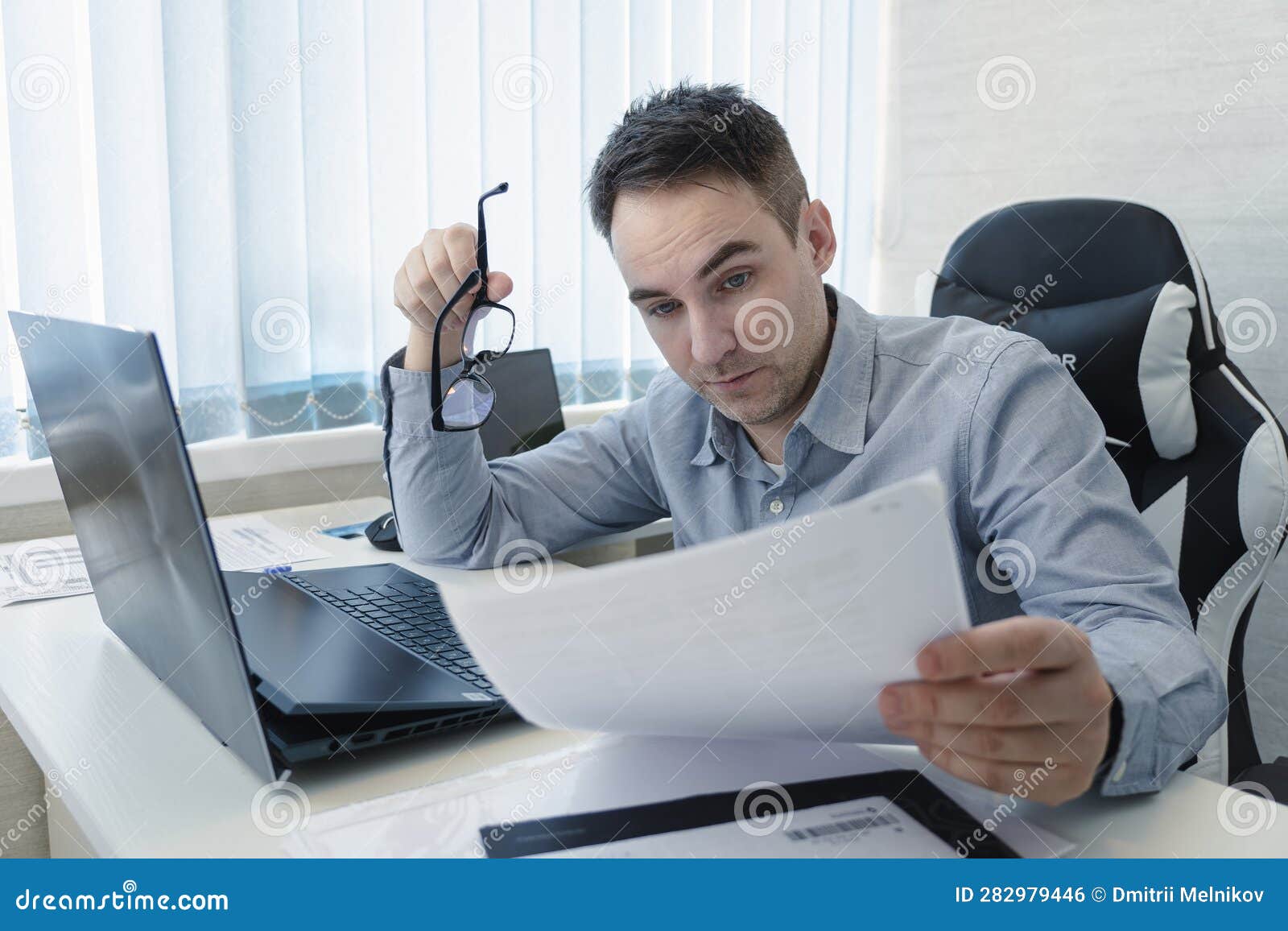 An Employee in the Office. Focus on Work. Attractive Young Businessman ...