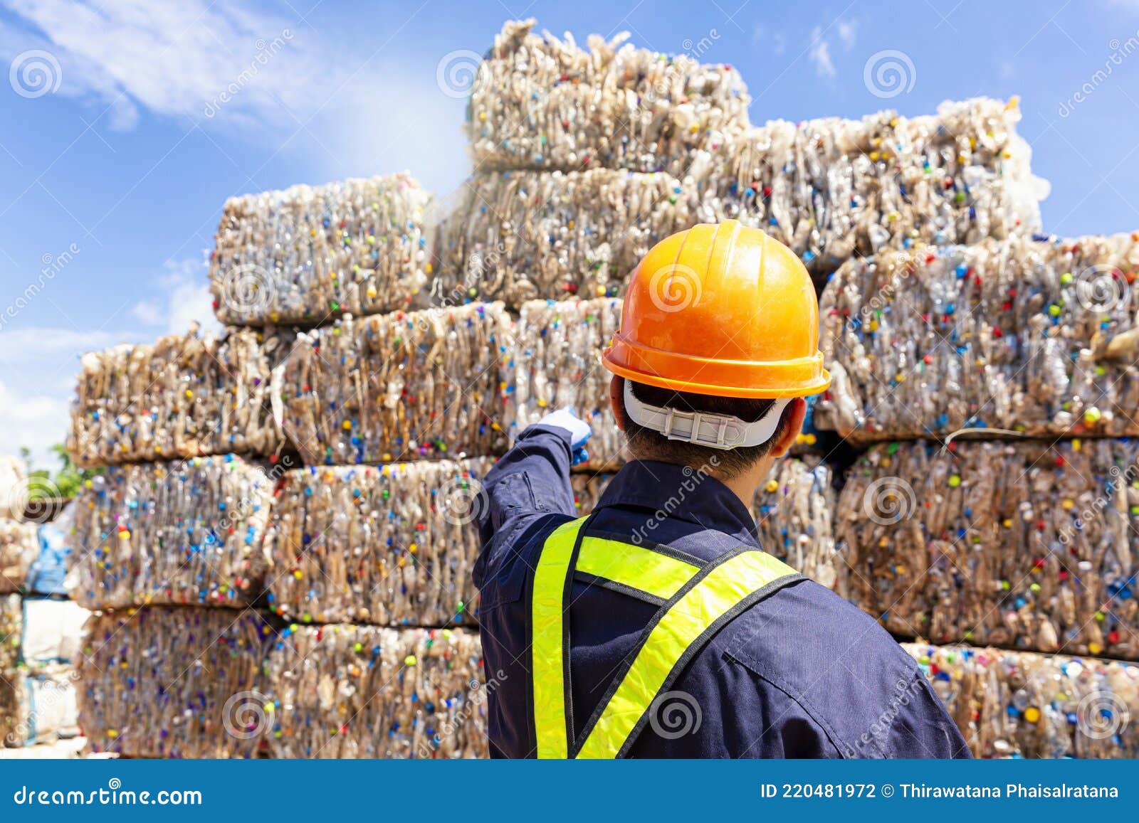 An Employee at a Recycling Plant is Pointing To Plastic Waste Being ...