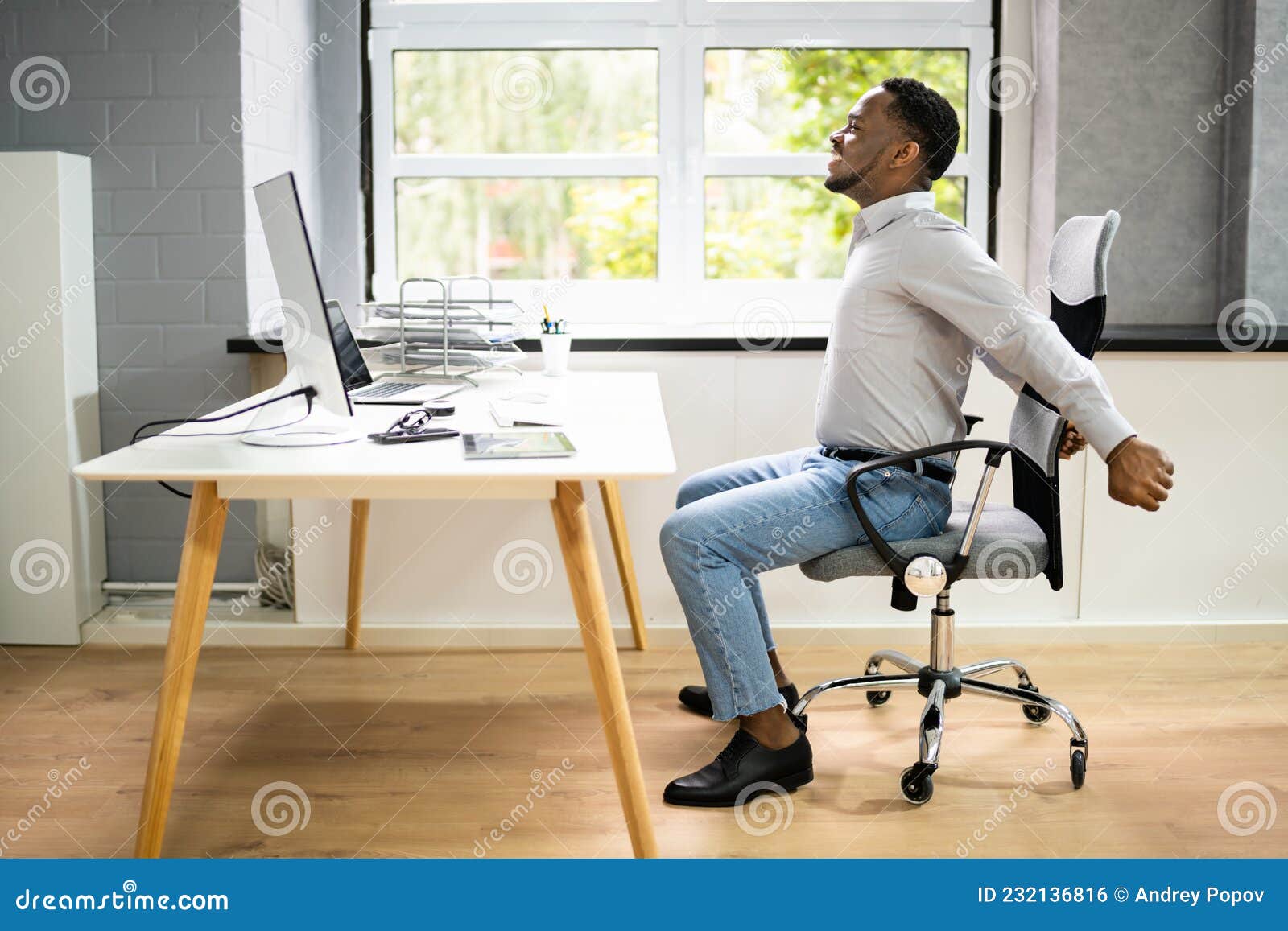Employee Stretching at Office Desk Stock Photo - Image of american ...