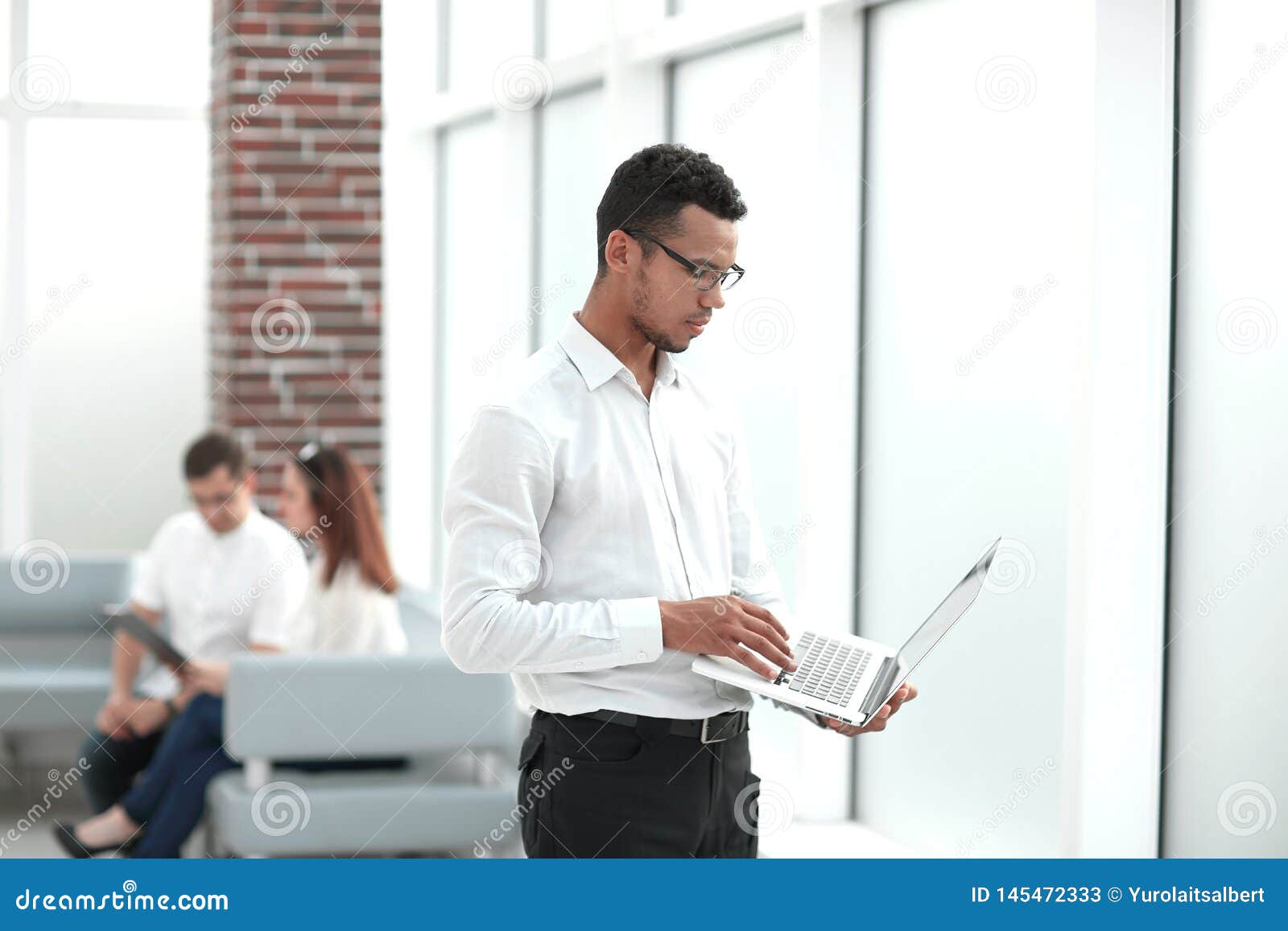 Employee Typing on a Laptop Standing in the Office. Stock Image - Image ...