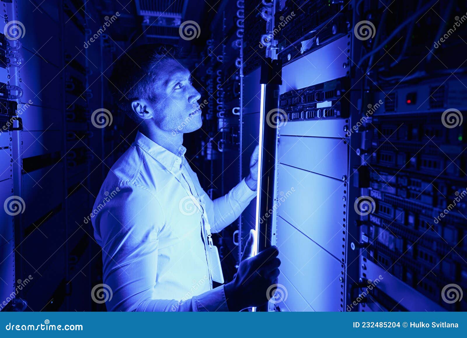 Employee Using Additional Lighting for Checking Hardware Equipment ...