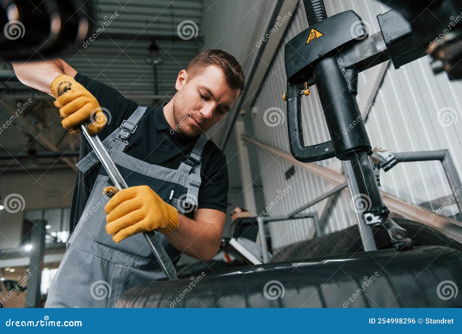 Employee at Work. Man in Uniform is in the Auto Service Stock Photo ...