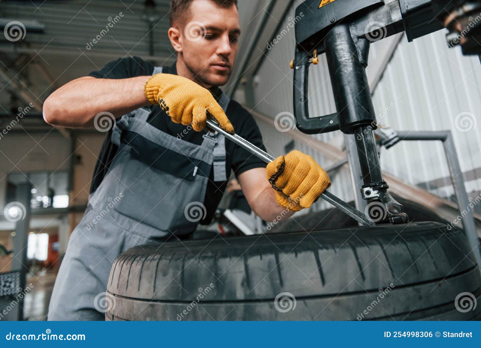 Employee at Work. Man in Uniform is in the Auto Service Stock Photo ...