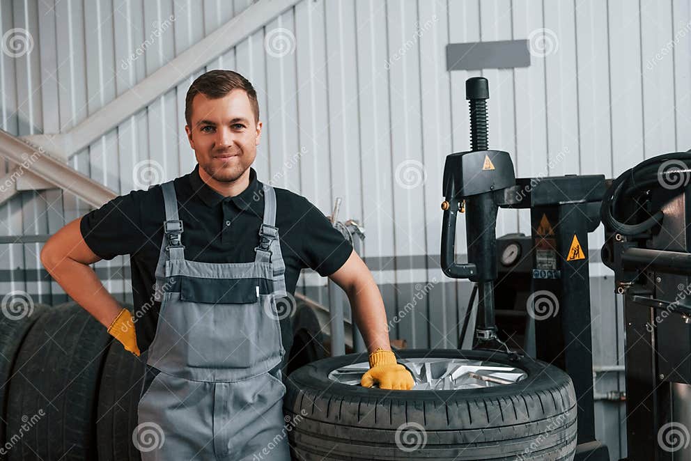 Employee at Work. Man in Uniform is in the Auto Service Stock Image ...