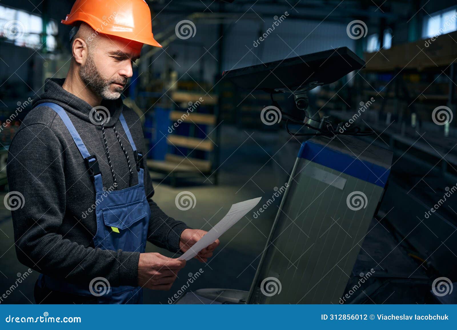 Employee Works with Production Documentation at the Workplace Stock ...