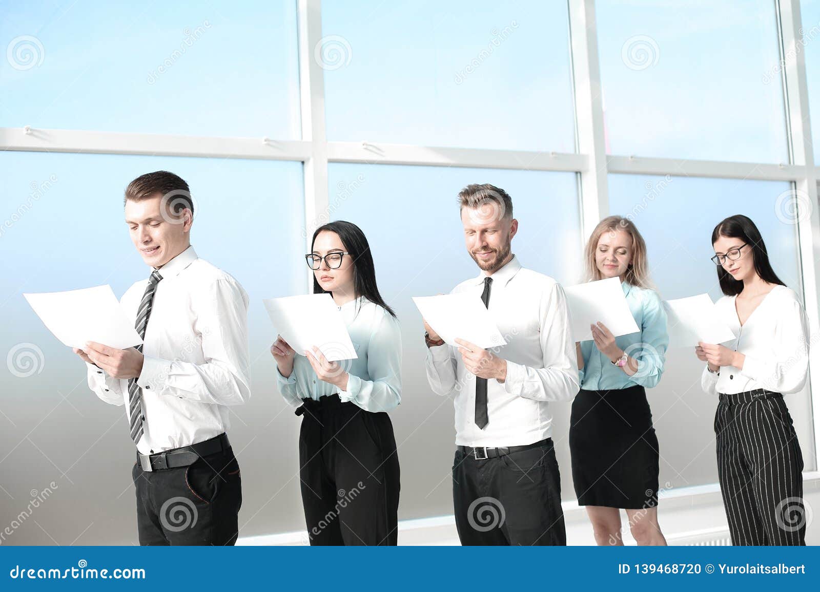Employees with Business Documents Standing in the Office Hallway Stock ...