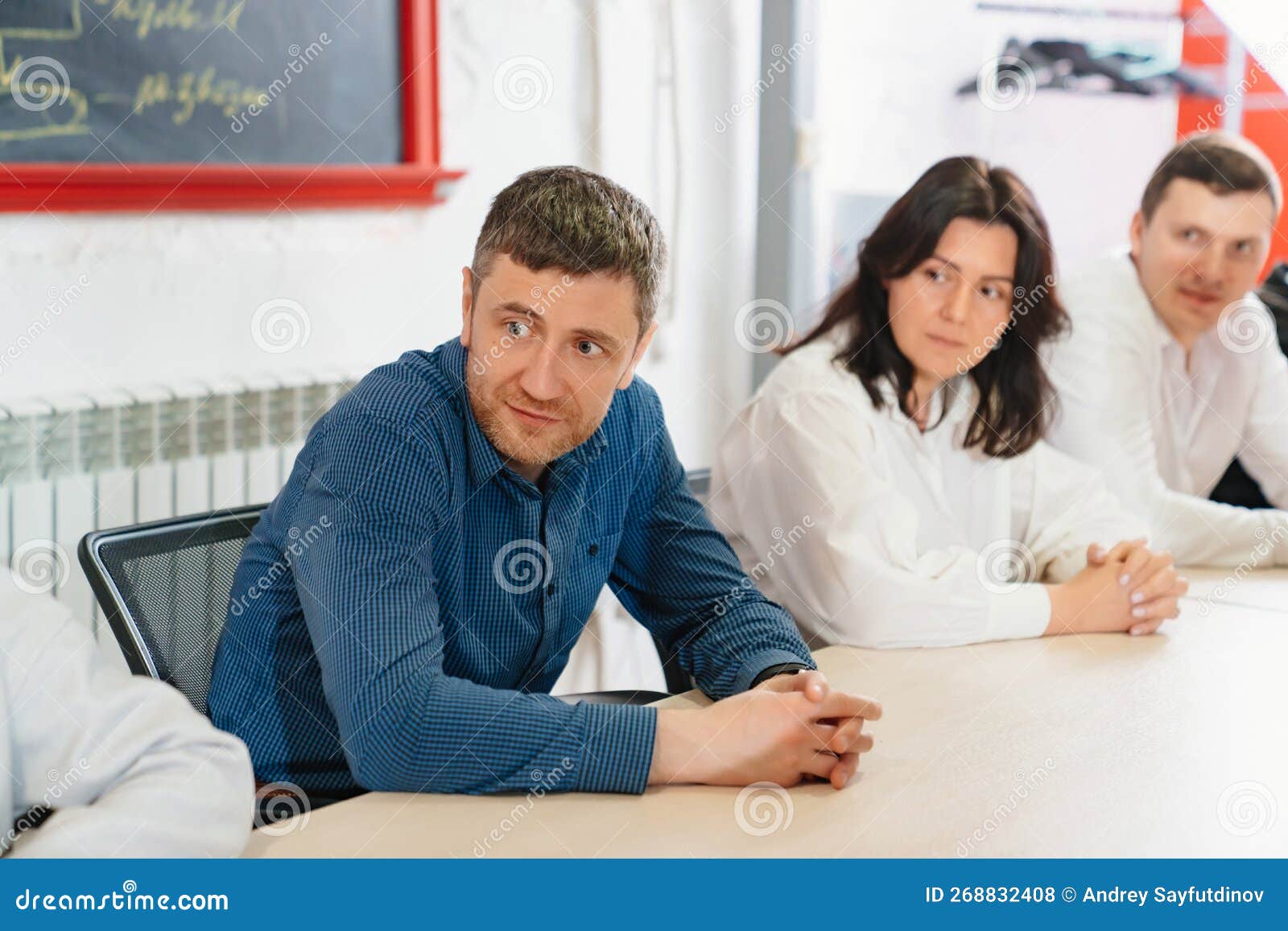 Employees of the Company Sit at a Large Table in a Meeting. Stock Photo ...