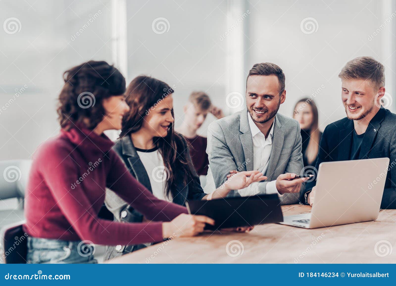 Employees Discuss Working Documents Sitting at a Desk Stock Photo ...