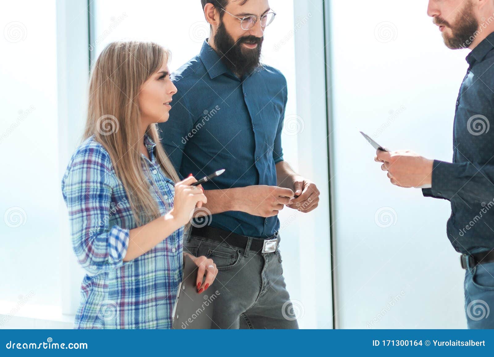 Employees Discussing Current Tasks Standing in the Office Stock Photo ...