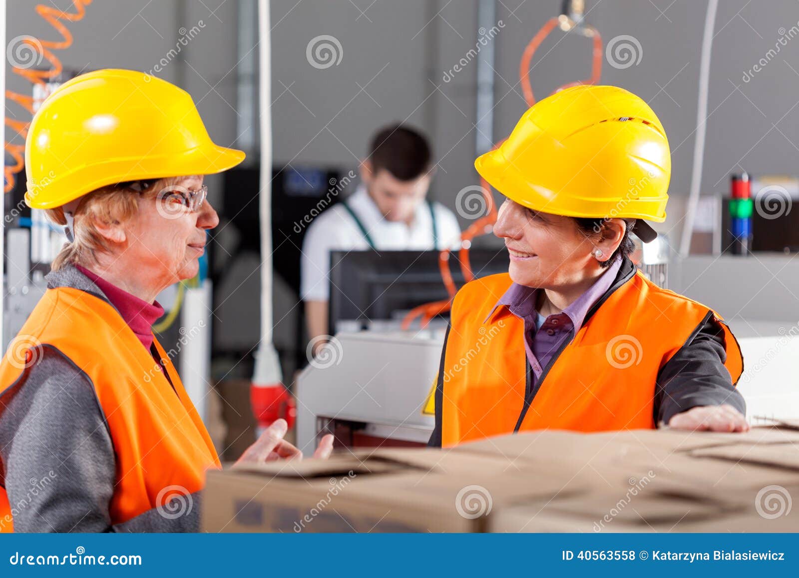 Employees Discussing at Production Area Stock Photo - Image of ...