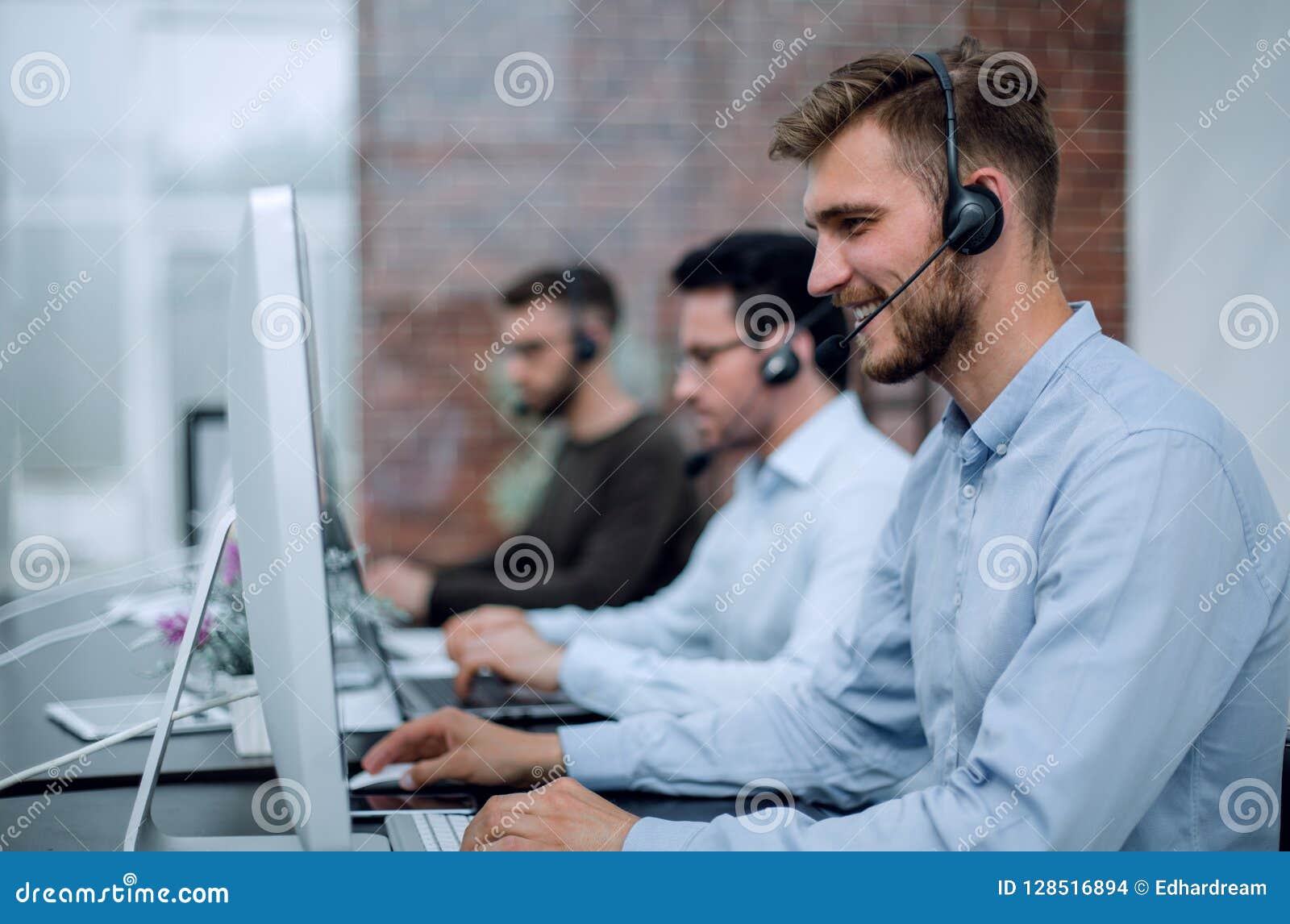 Employees with a Headset in the Workplace in the Business Center Stock ...