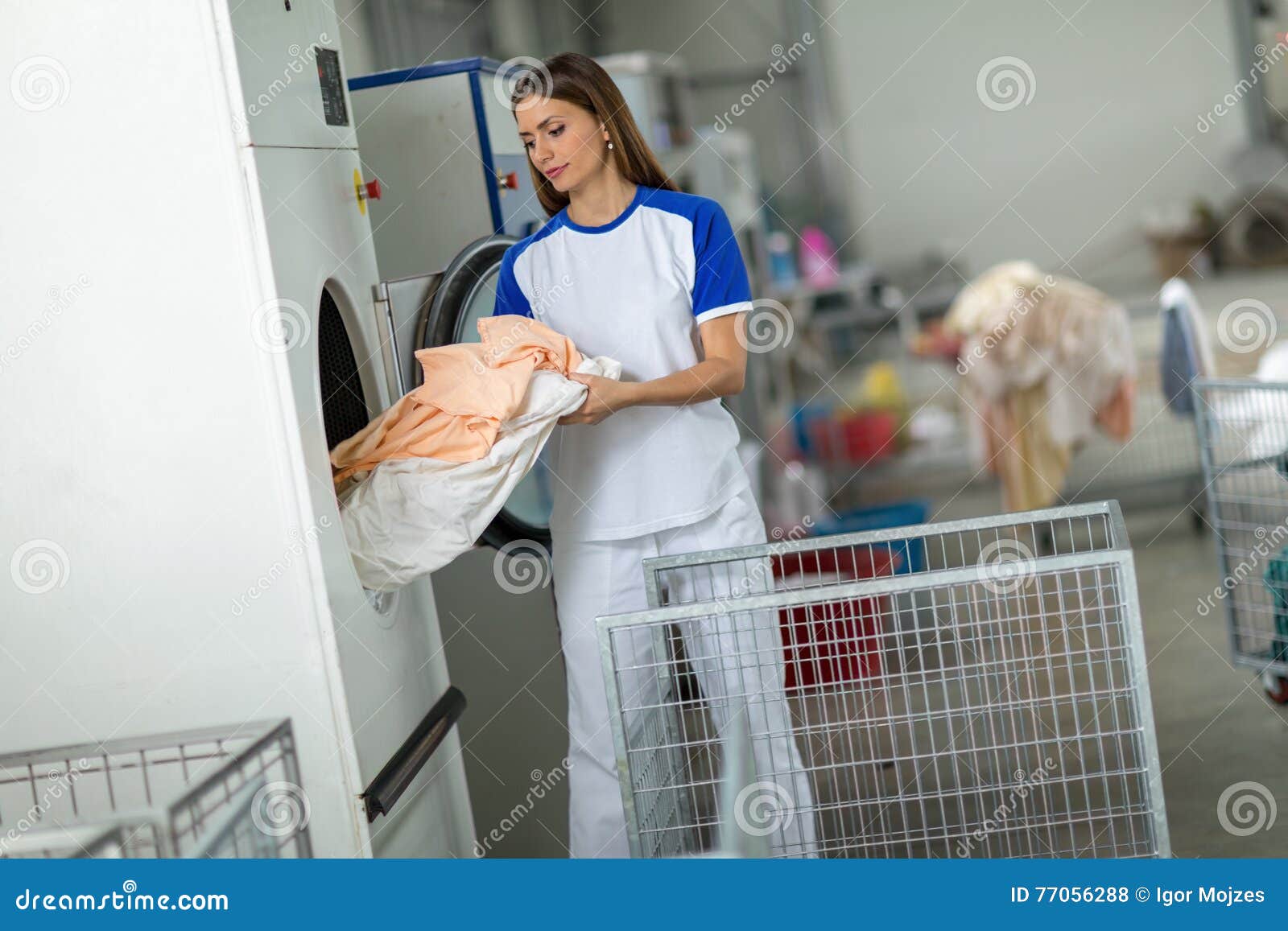 Employees Putting Clothes in Washing Machine Stock Photo - Image of ...