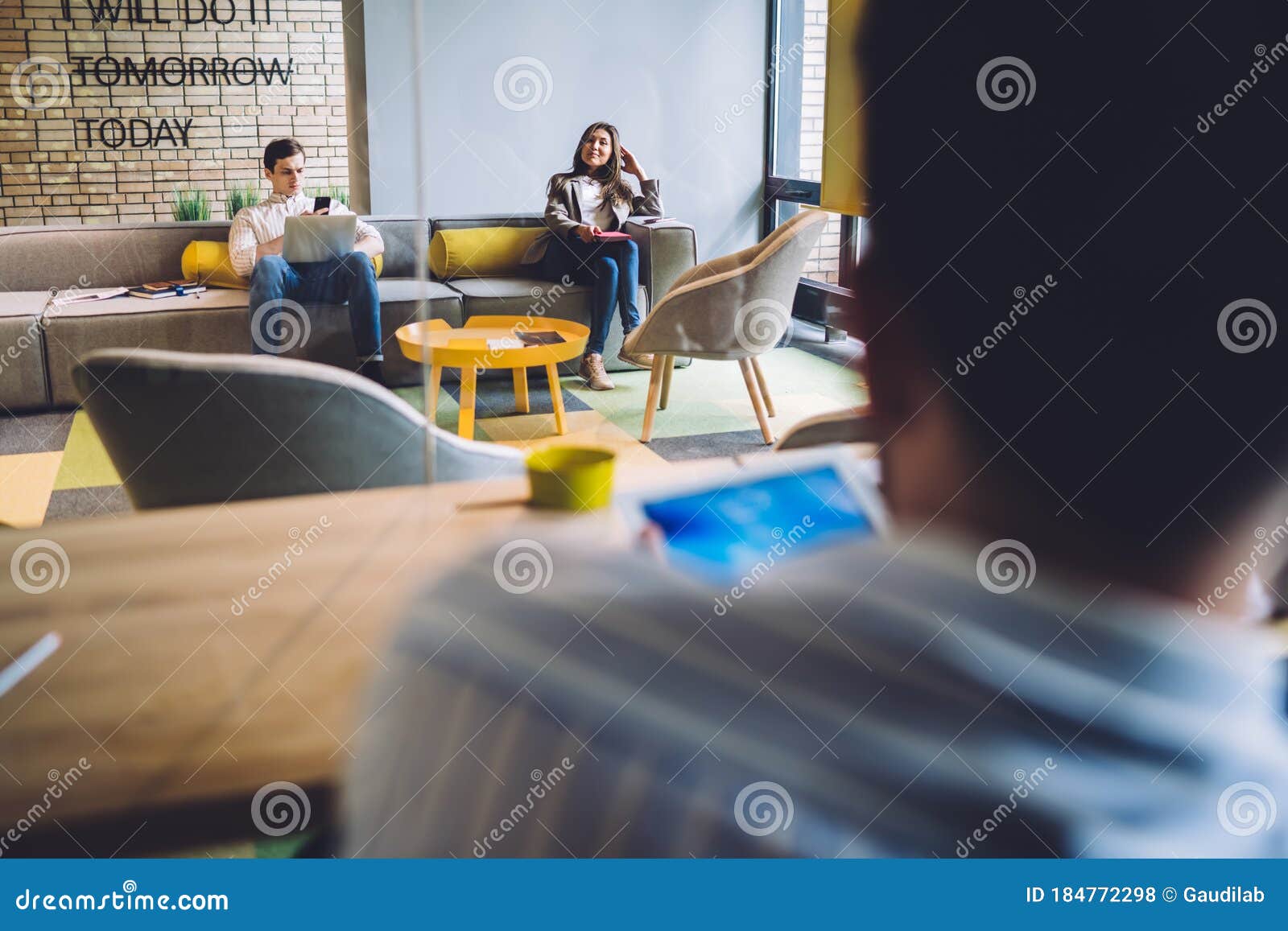 Employees Sitting on Couch in Modern Workplace Stock Photo - Image of ...