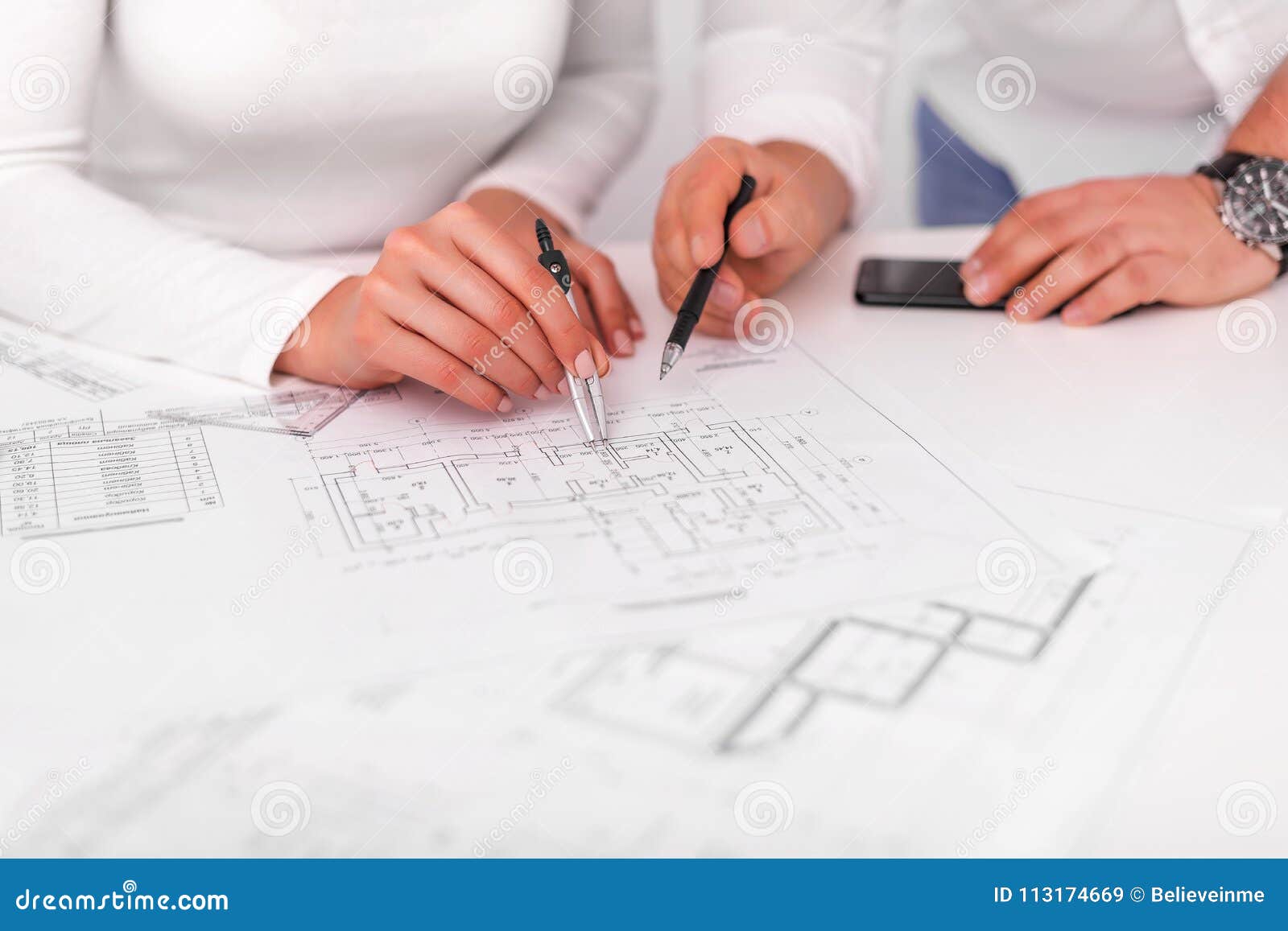 Employees Work on Blueprints or Engineering Plans in the Office ...