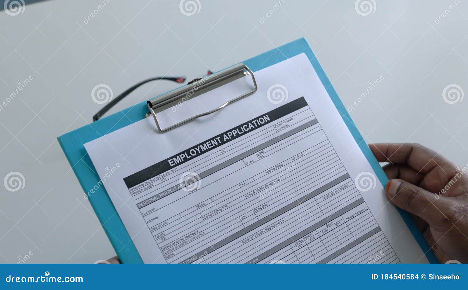 Employment Application Form. Attached on a Blue Clipboard on an Office ...