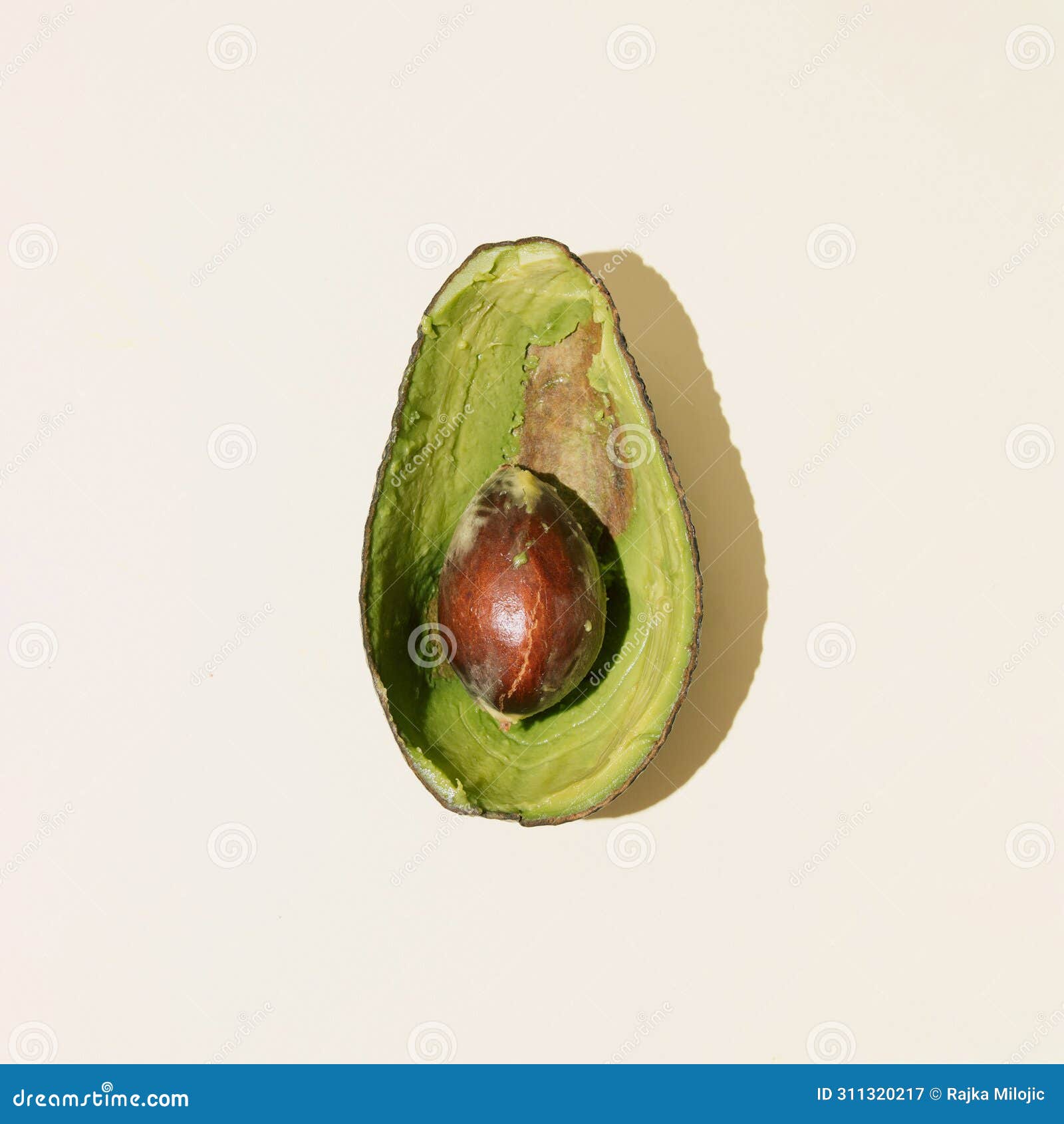 Emptied Shell of an Avocado and Seed Avocado with Copy Space on Beige ...