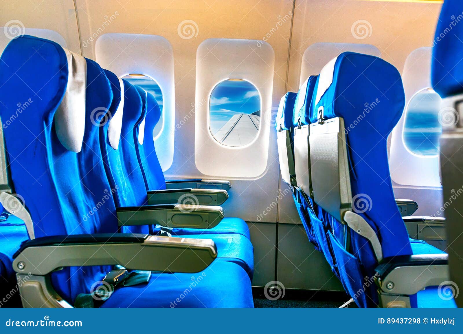 Empty Aircraft Cabin With Male Cabin Crew Working In Galley. Premium ...