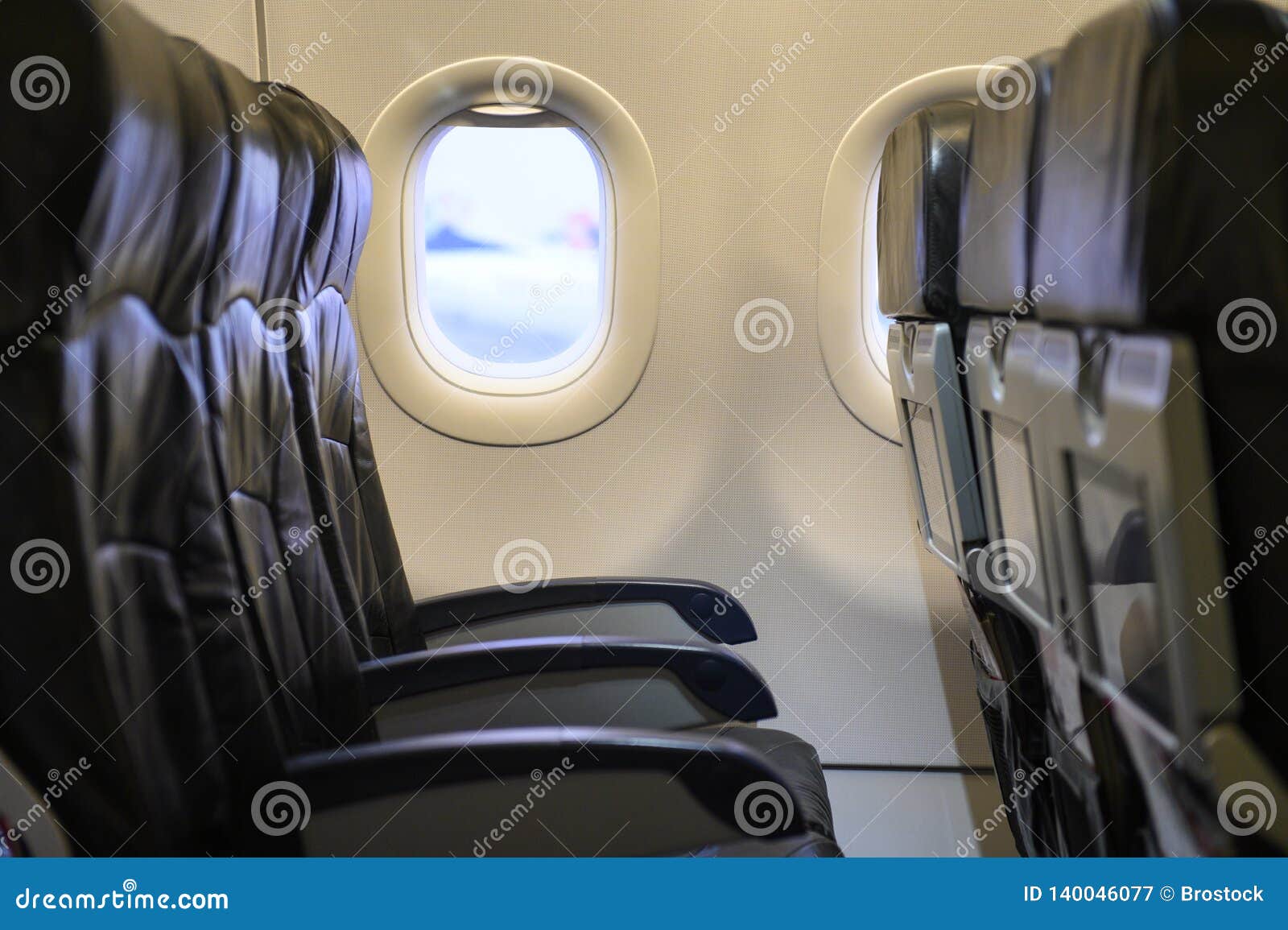 Empty Aircraft Cabin With Male Cabin Crew Working In Galley. Premium ...