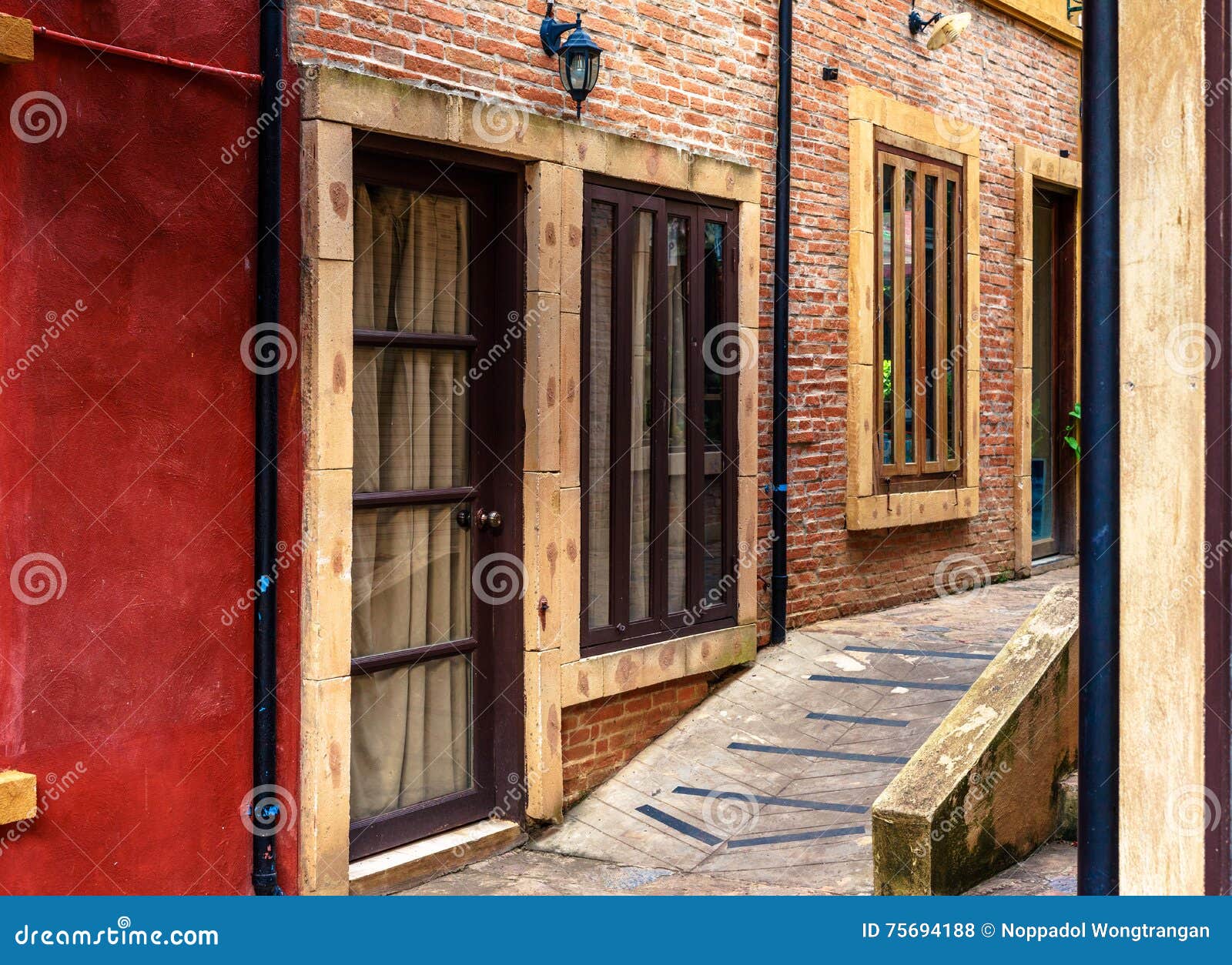 Empty Alleyway with Windows and Doors on Brick Wall Stock Photo - Image ...