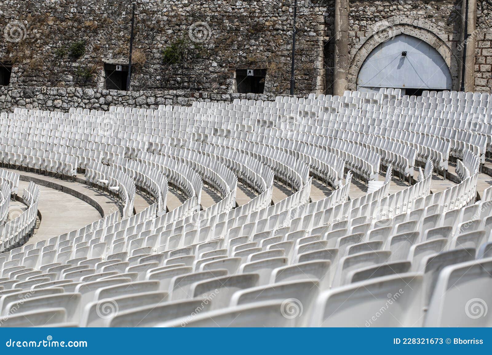 Empty Auditorium With Gray Plastic Chairs In An Ancient Amphitheater ...