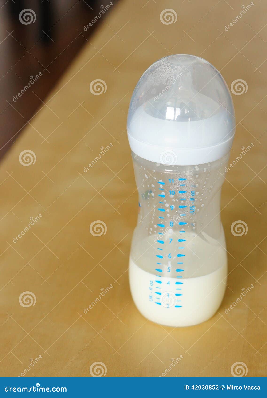 Almost empty baby bottle stock photo. Image of table - 42030852