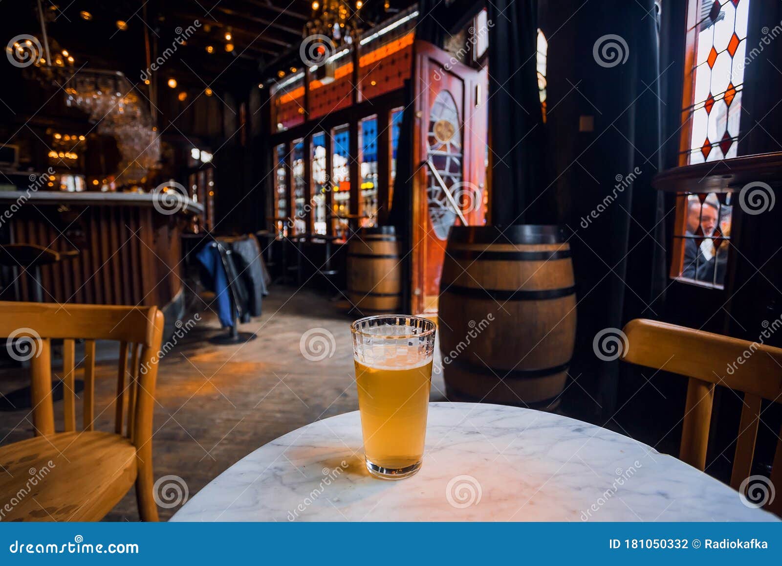 Empty Bar with only One Occupied Table and Beer Glass. No Visitors ...