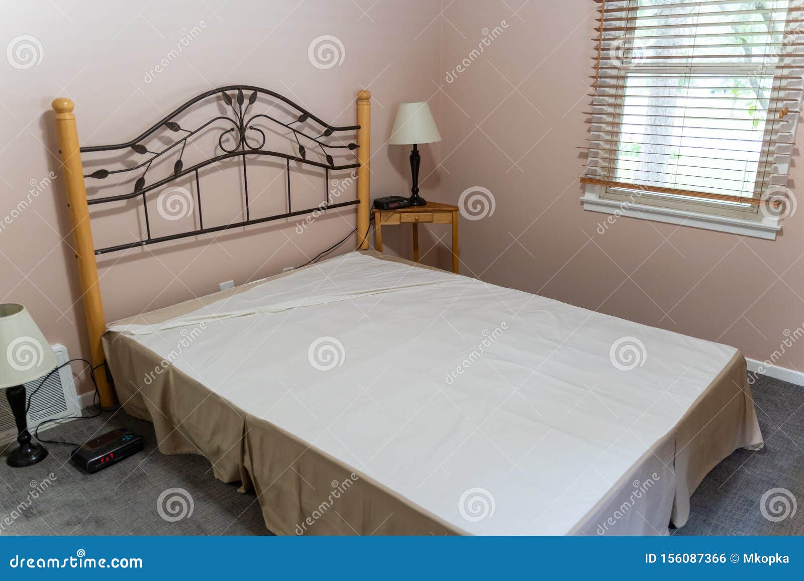 Empty Bedroom with only a Bed Frame, Box Spring Mattress and Night ...