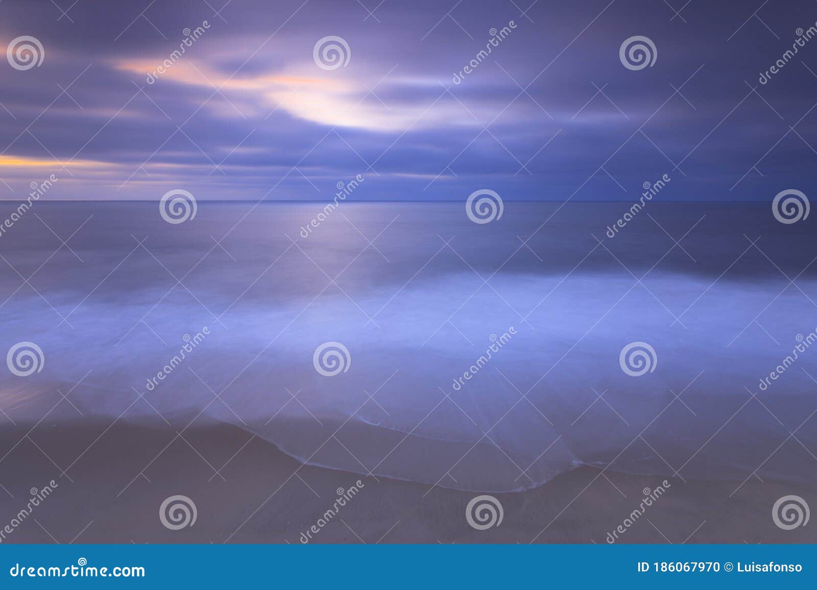 Empty blue beach at sunset stock photo. Image of rock - 186067970