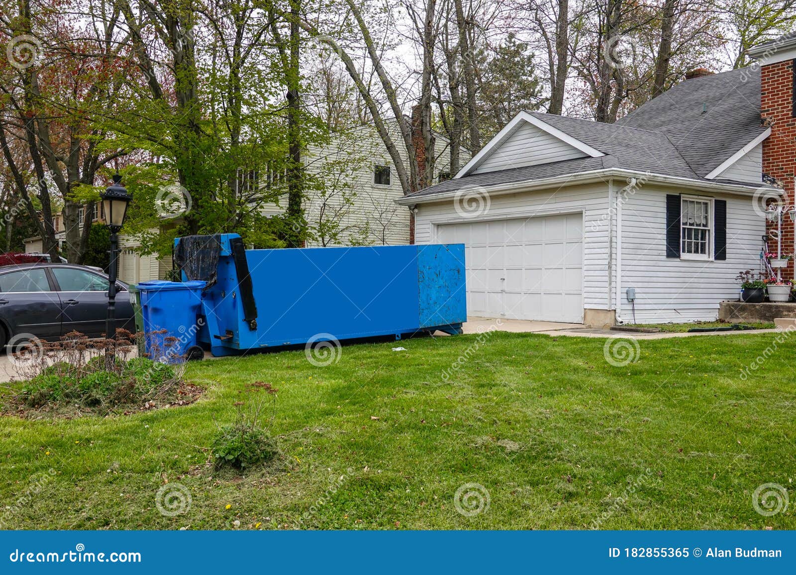 Blue Dumpster Filled With Tree Evergreen Branches And A Blue Outhouse ...