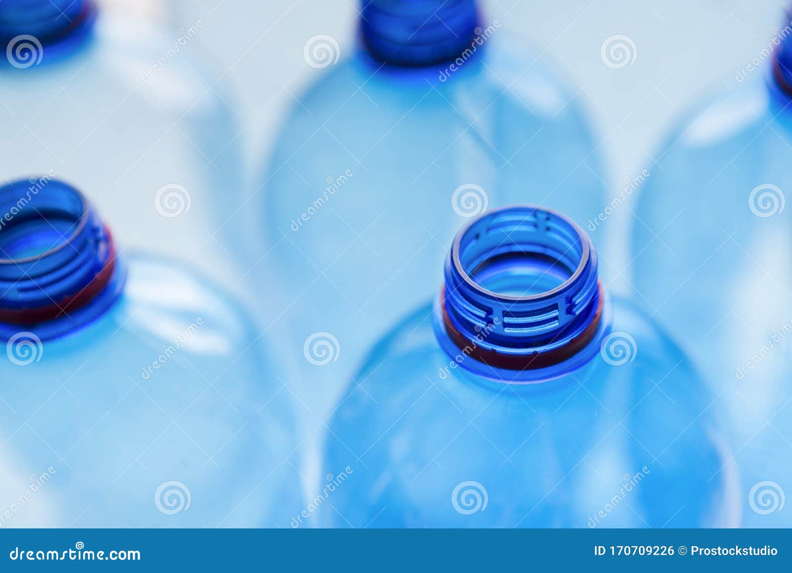 Empty Blue Plastic Bottles on Blurred Background Stock Photo - Image of ...