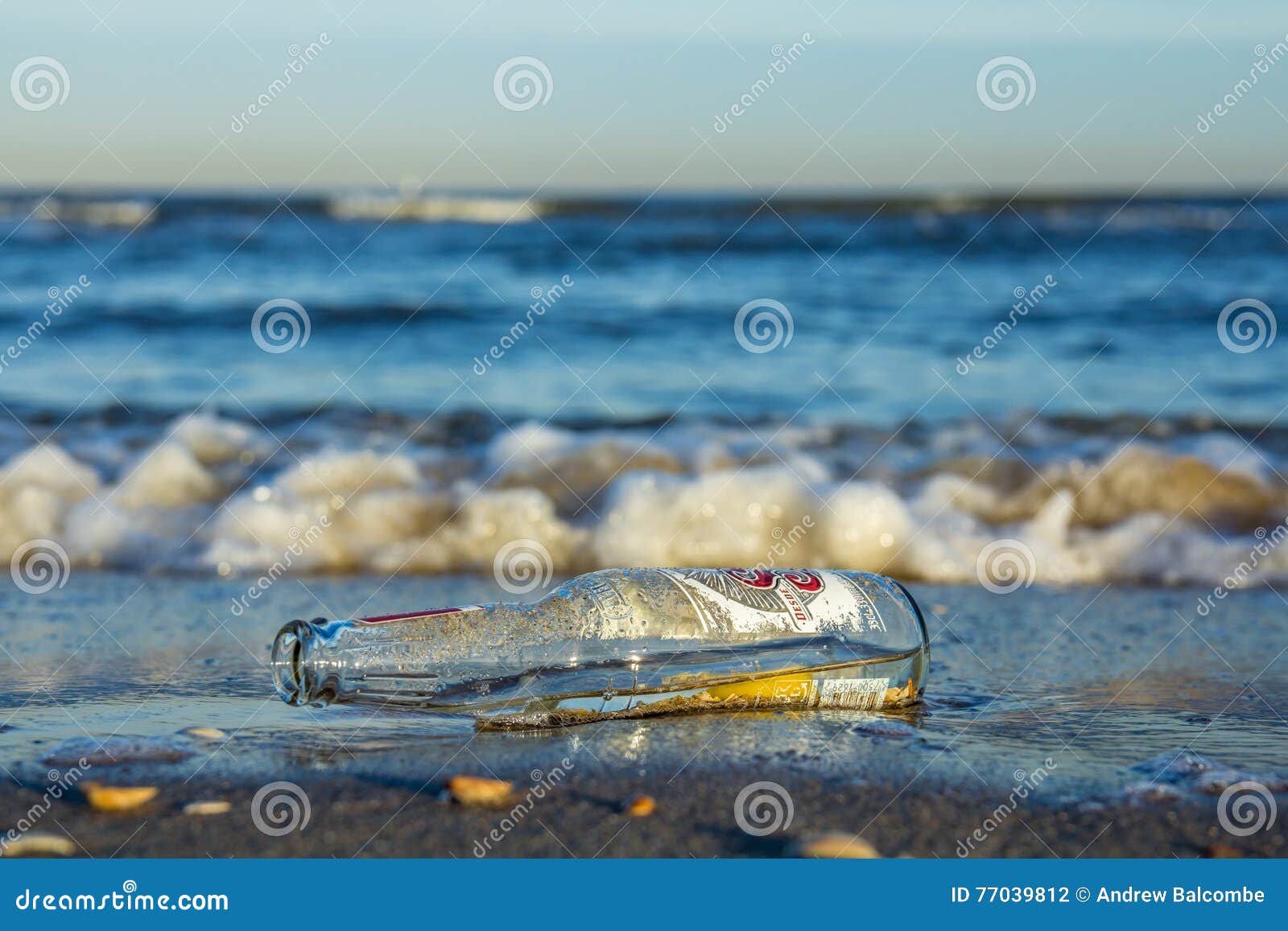 Empty Bottle Lying in the Surf Editorial Photography - Image of garbage ...