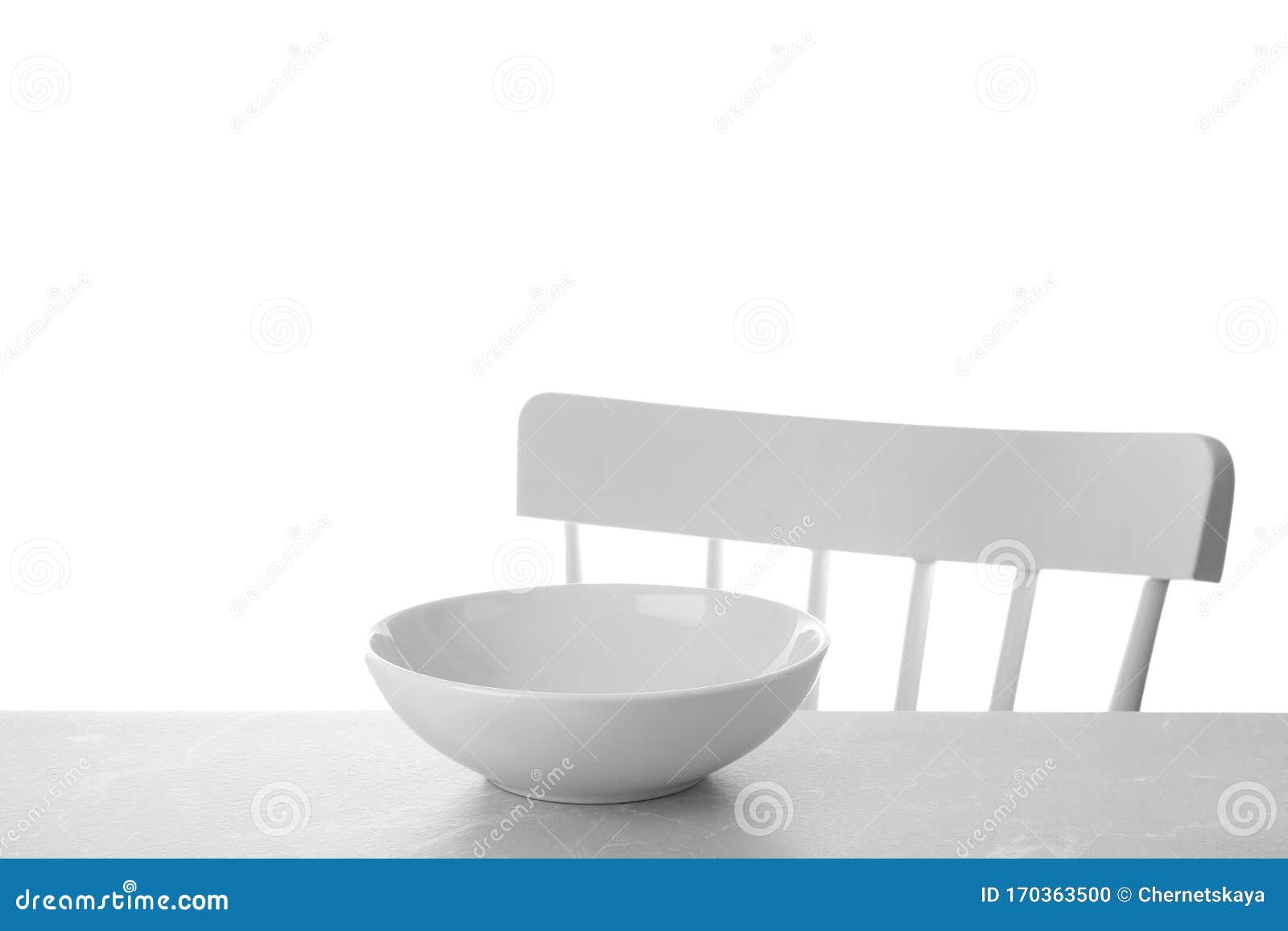 Empty Bowl on Light Table Against White Background Stock Photo - Image ...