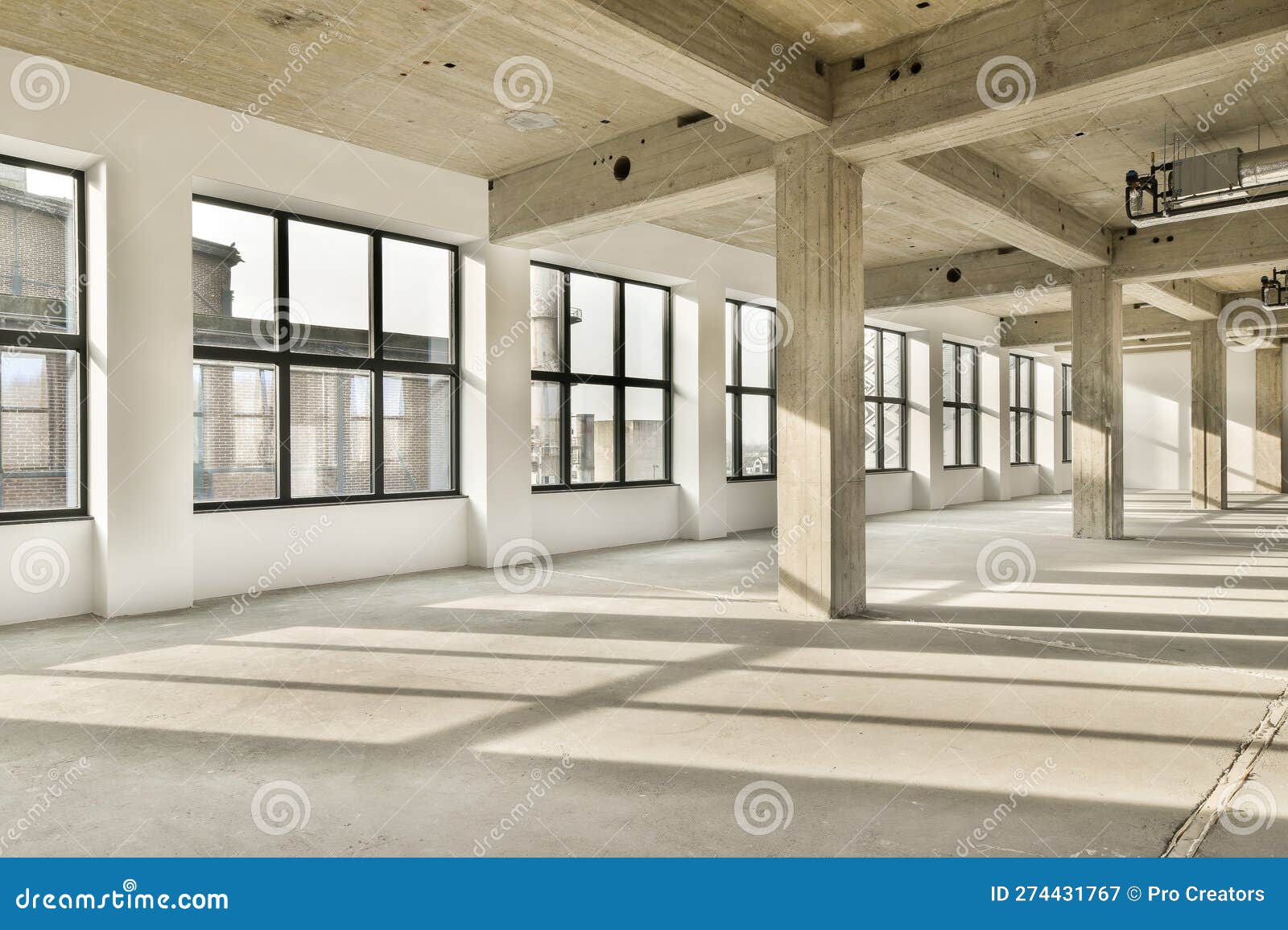 An Empty Room with Large Windows and a Concrete Floor Stock Image ...