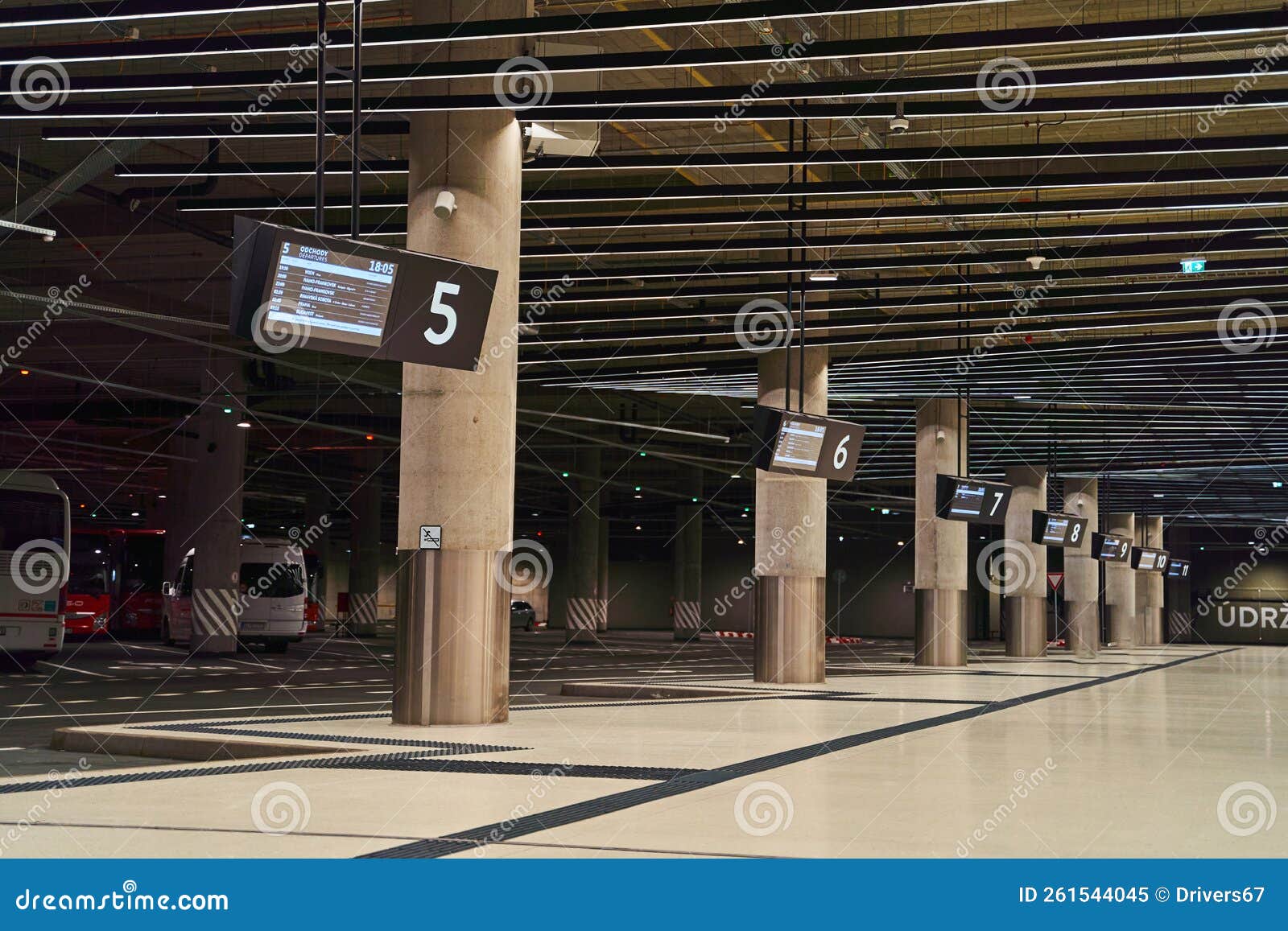 An Empty Bus Station Inside with Parked Buses and Large Columns ...