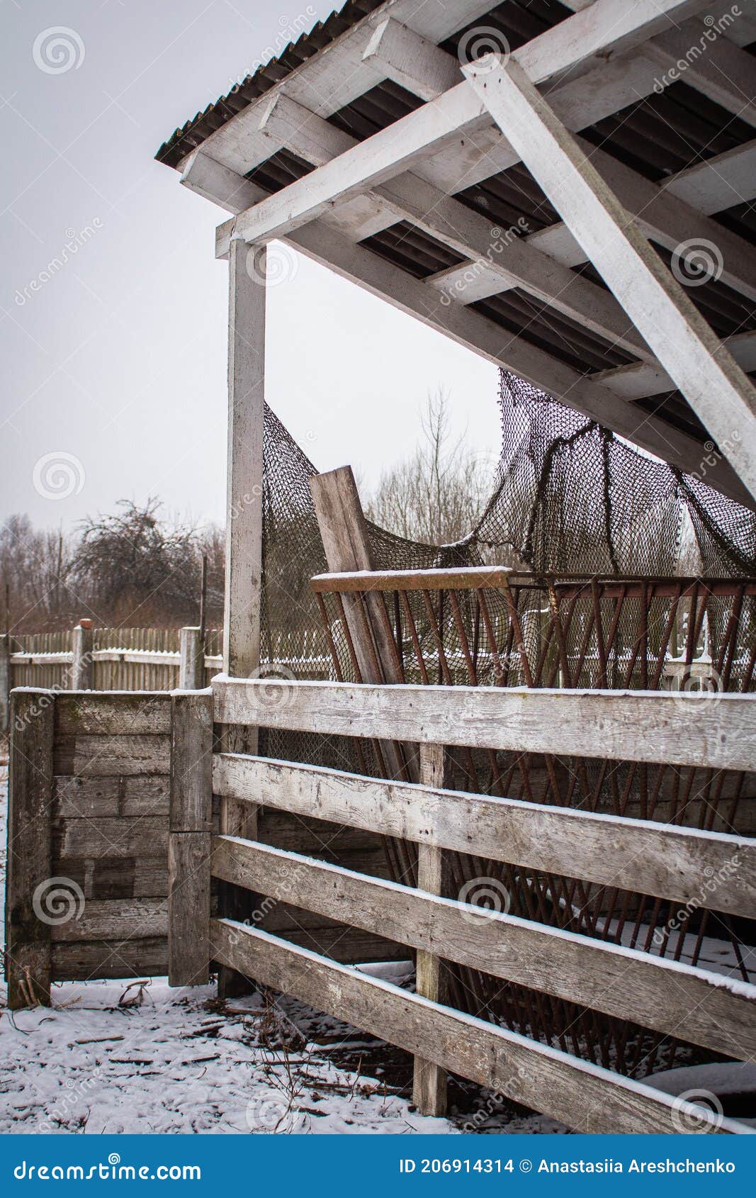 Empty Cattle Paddock In The Foreground With A Hay Feeder Stock Photo ...