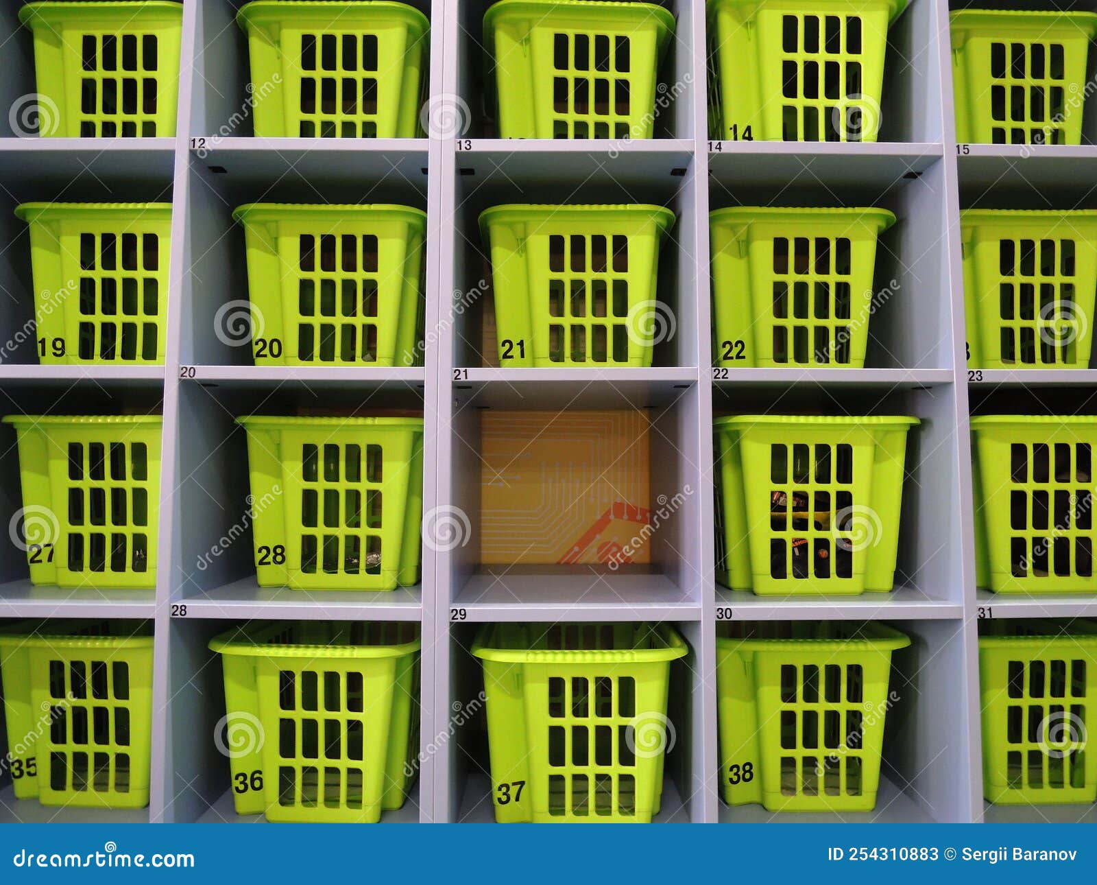 Empty Cell among Filled Cells with Plastic Storage Boxes at Storage ...