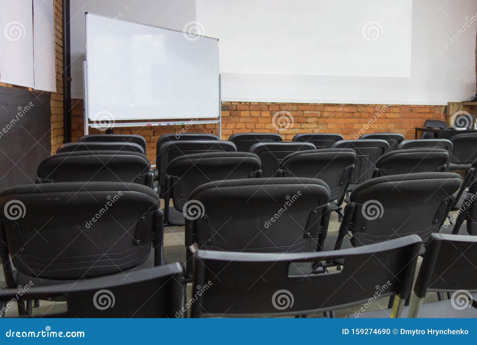 Empty Chairs Rows in Front of White Board and Wall Display before ...