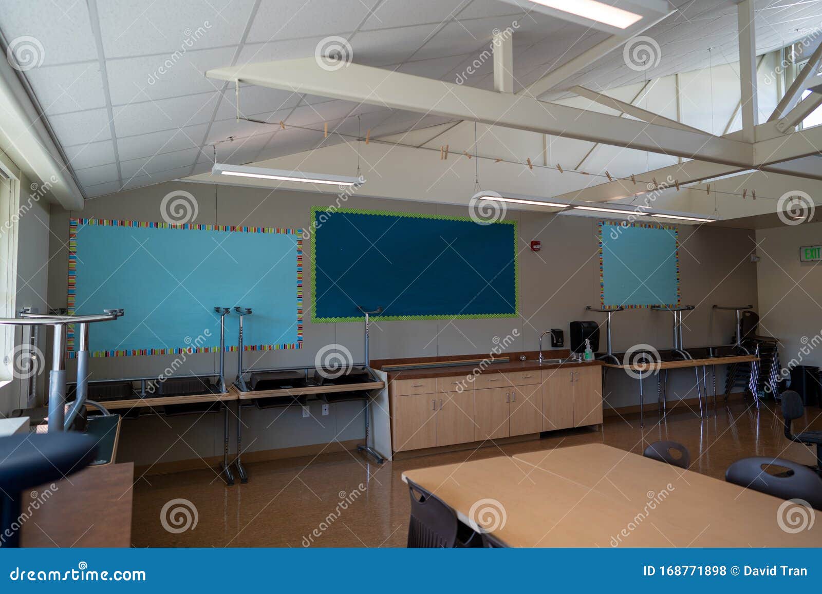 Empty Classroom with Blank Decorations and Tables and Chairs Stacked ...