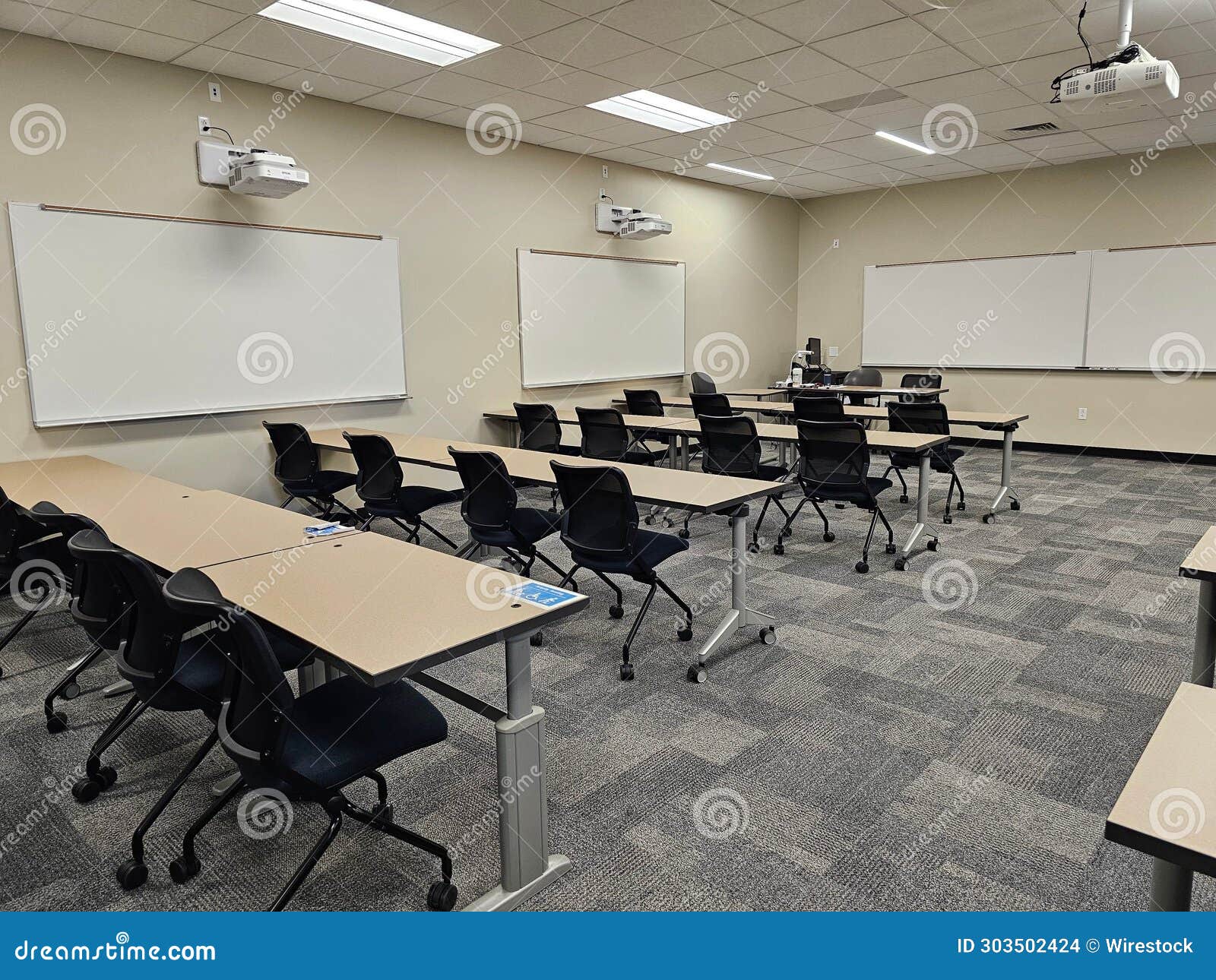 Empty Classroom Interior, with Rows of Desks and a Projector Suspended ...