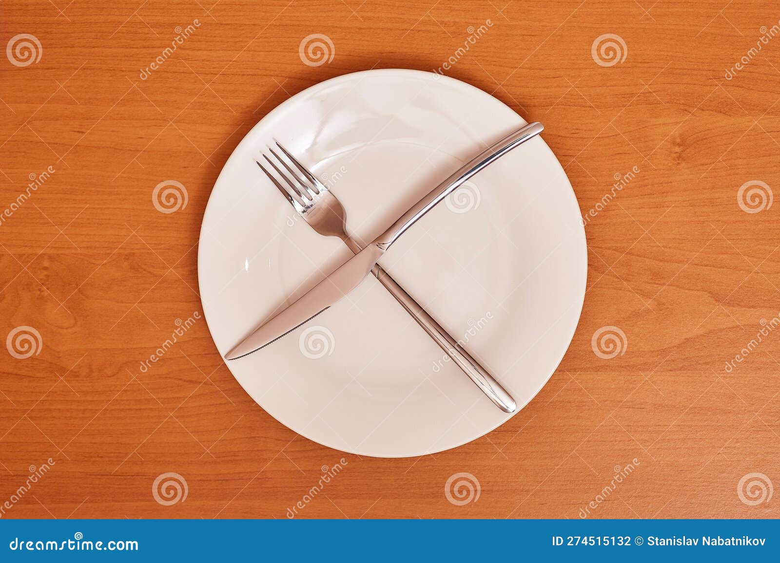 Empty and Clean White Plate with Fork and Knife on a Wooden Table As an ...