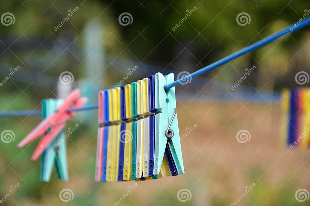 Empty Colorful Clothes Pegs on String in Garden Stock Image - Image of ...