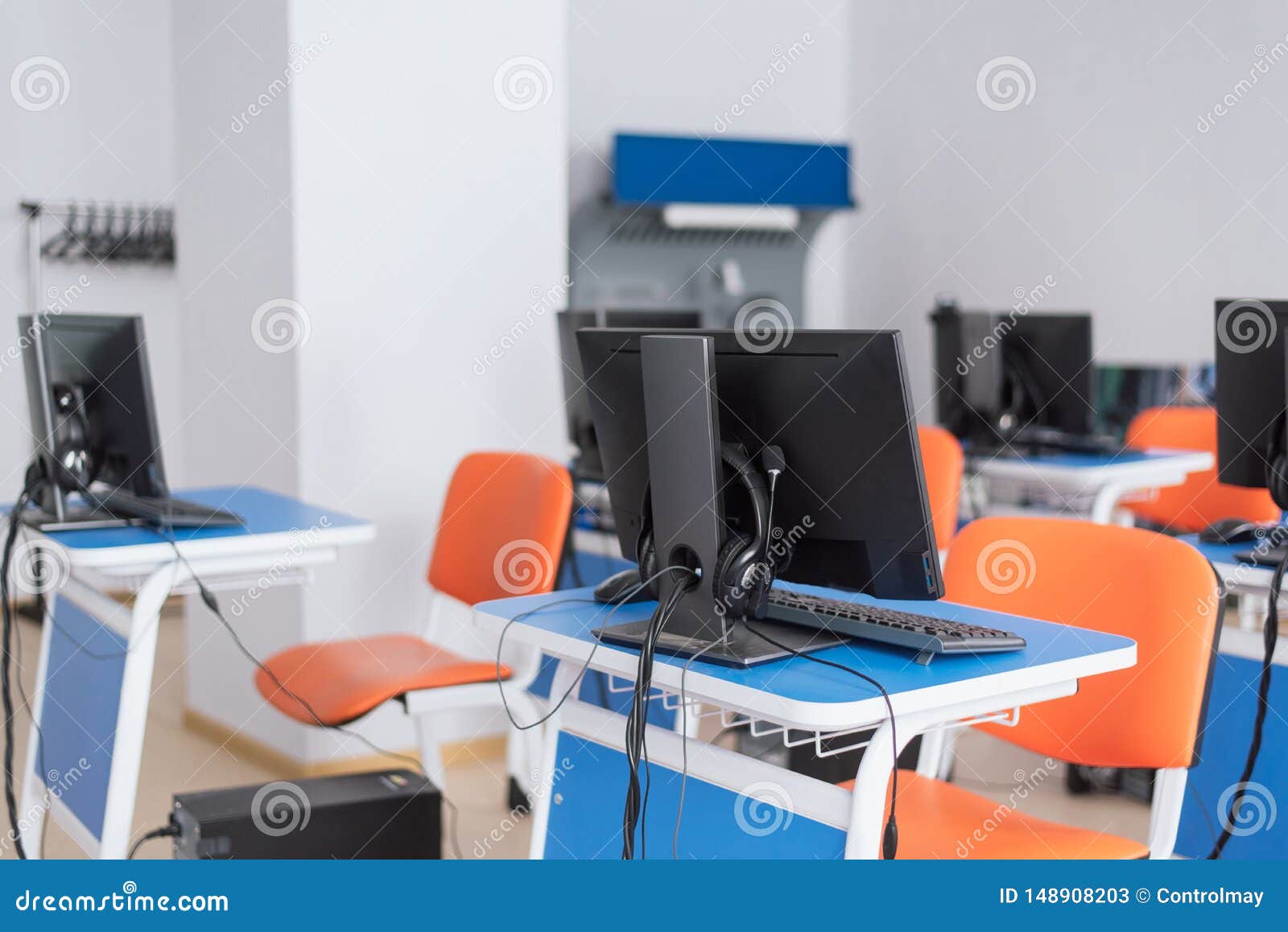 Empty Computer Classroom with Bright Blue Desks and Orange Chairs ...