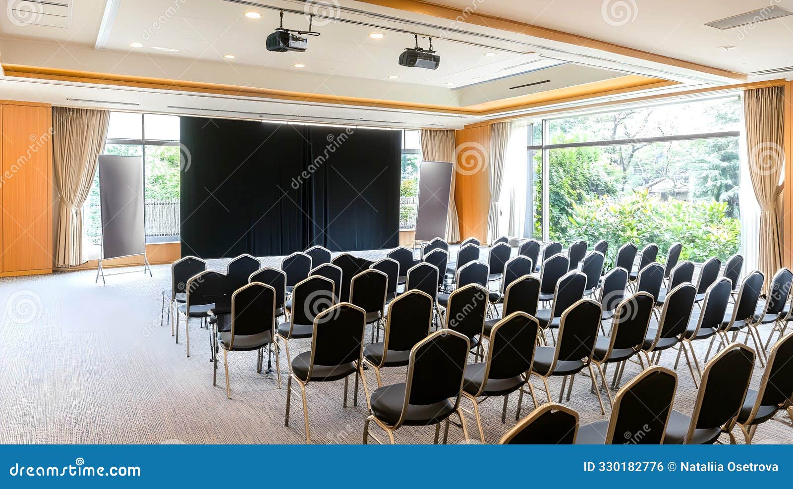Empty Conference Room with Rows of Chairs Facing a Stage and Large ...