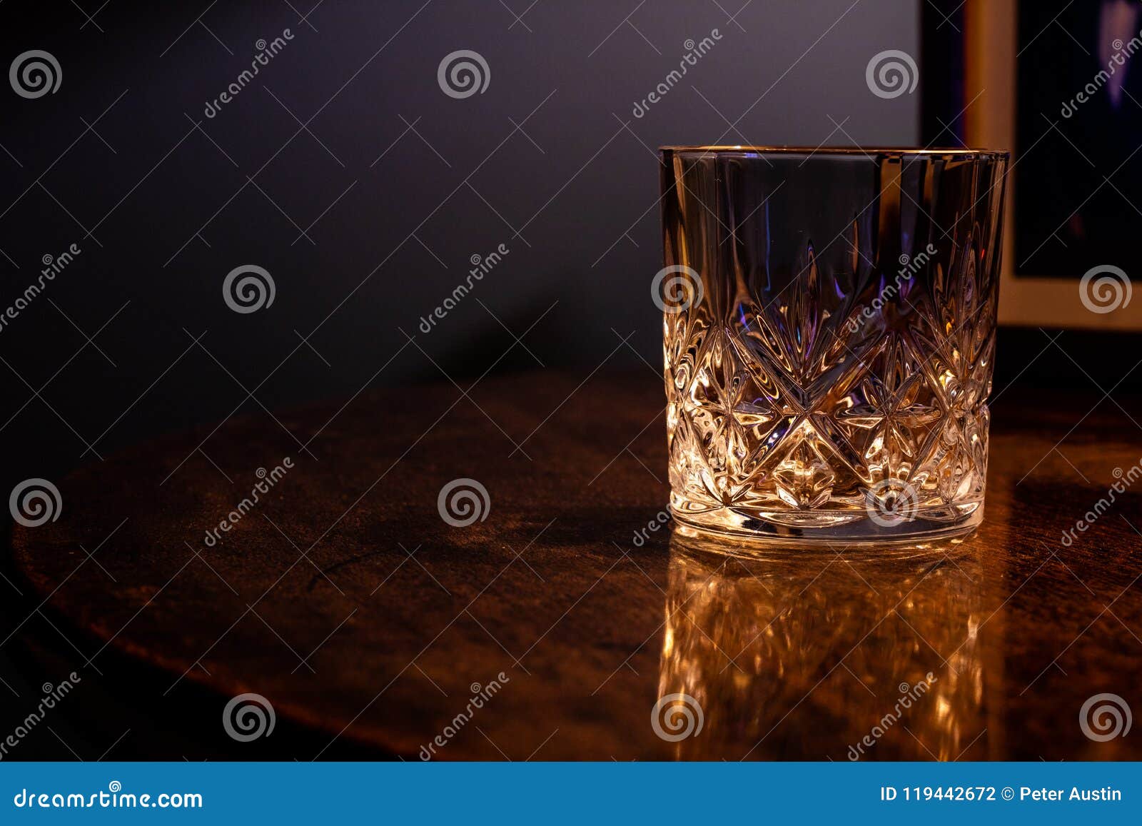 An Empty Crystal Glass Resting on on a Table with a Dark Wood Gr Stock ...