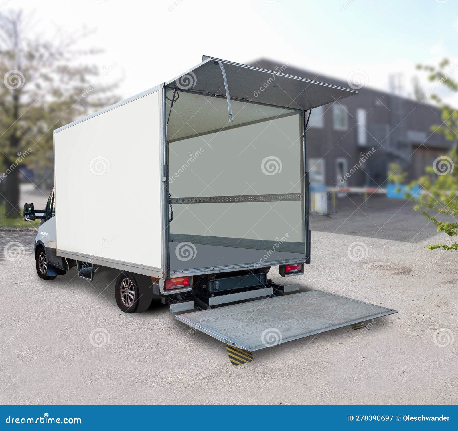 Empty Delivery Truck with Tailgate Open in Front of Industrial Building ...