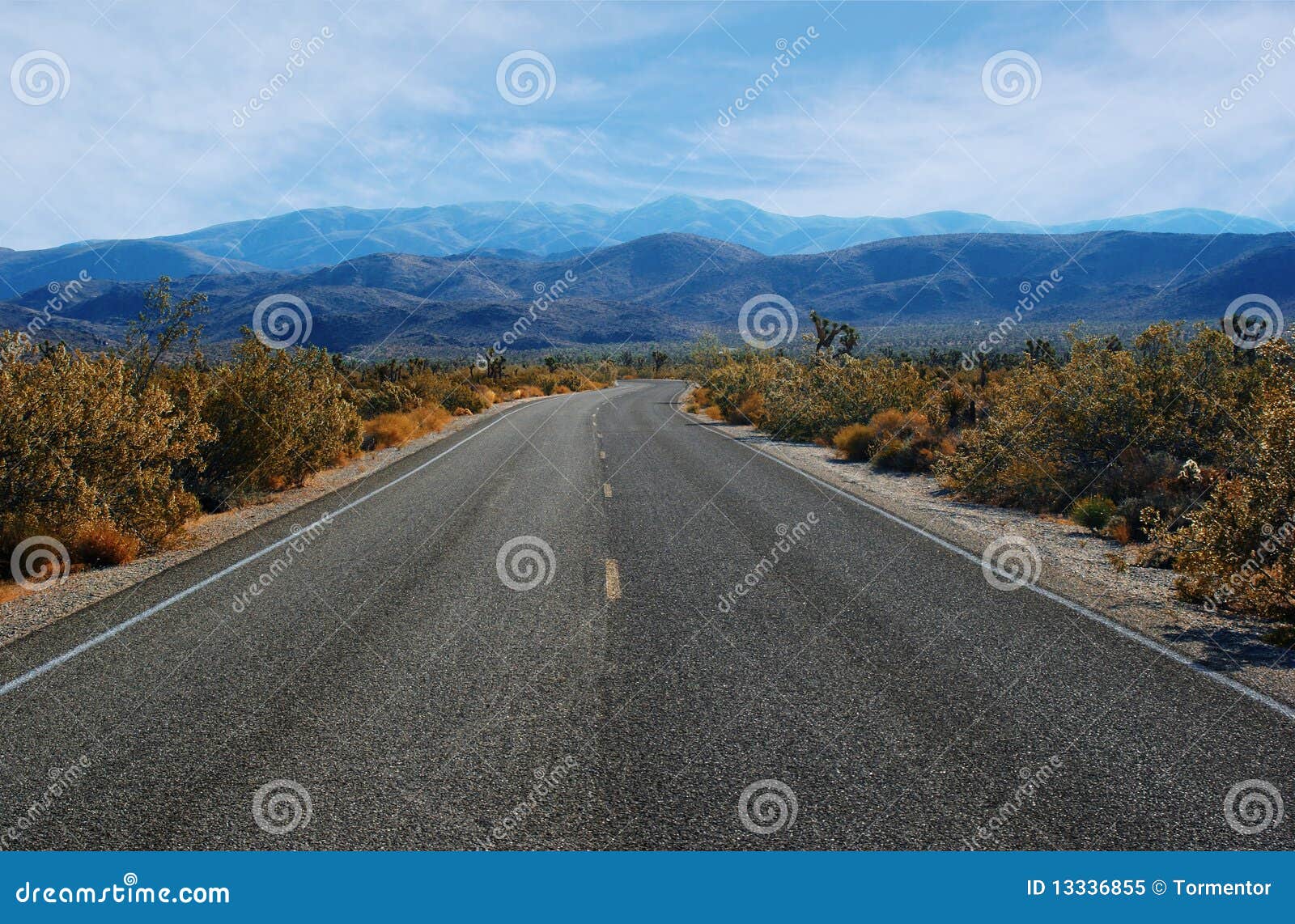 Empty Desert Road With Open Sky And Distant Mountains In Nevada Royalty ...