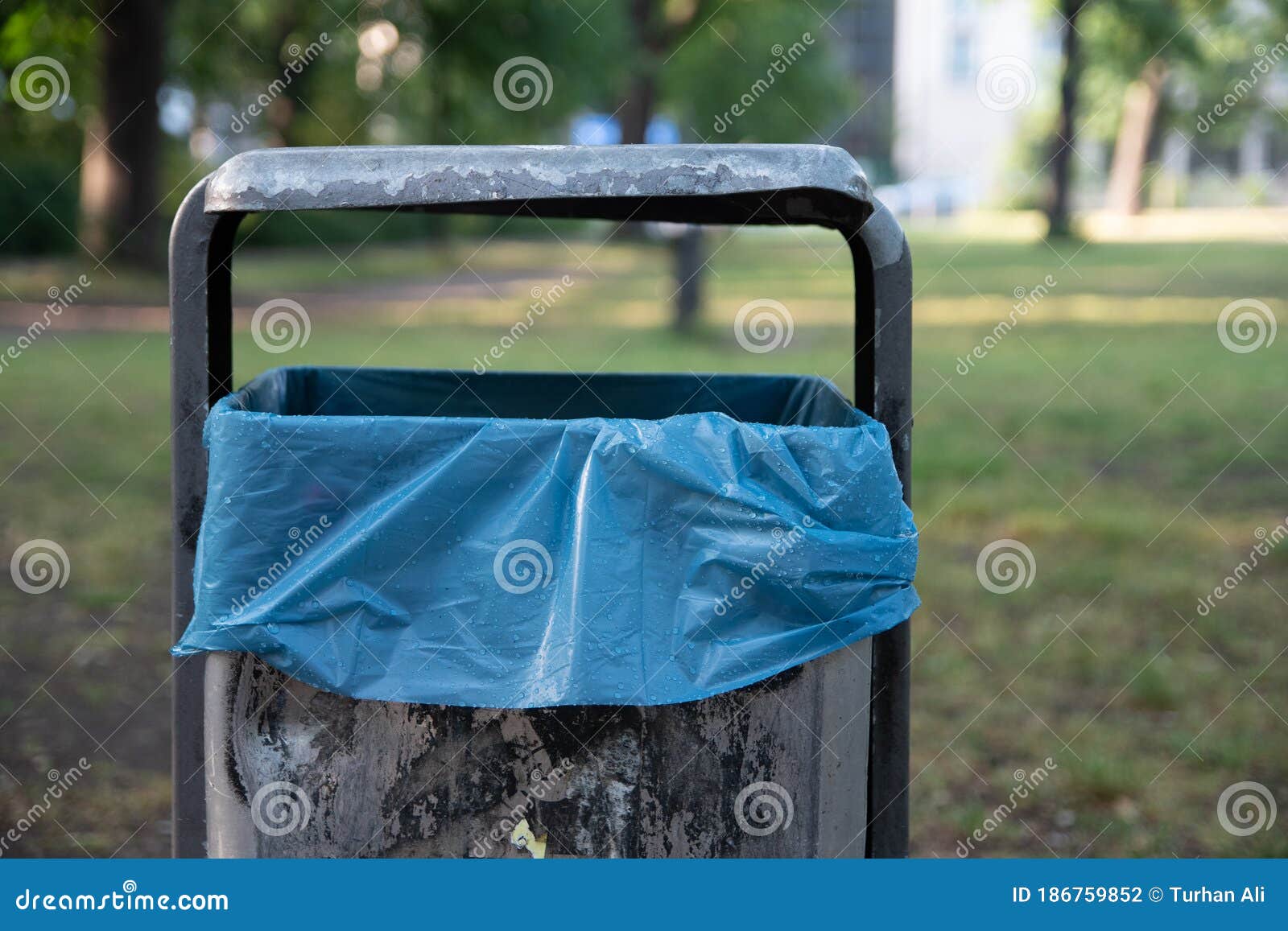 Empty, Dirty and Damaged Trash Bin in a Park Stock Photo - Image of ...