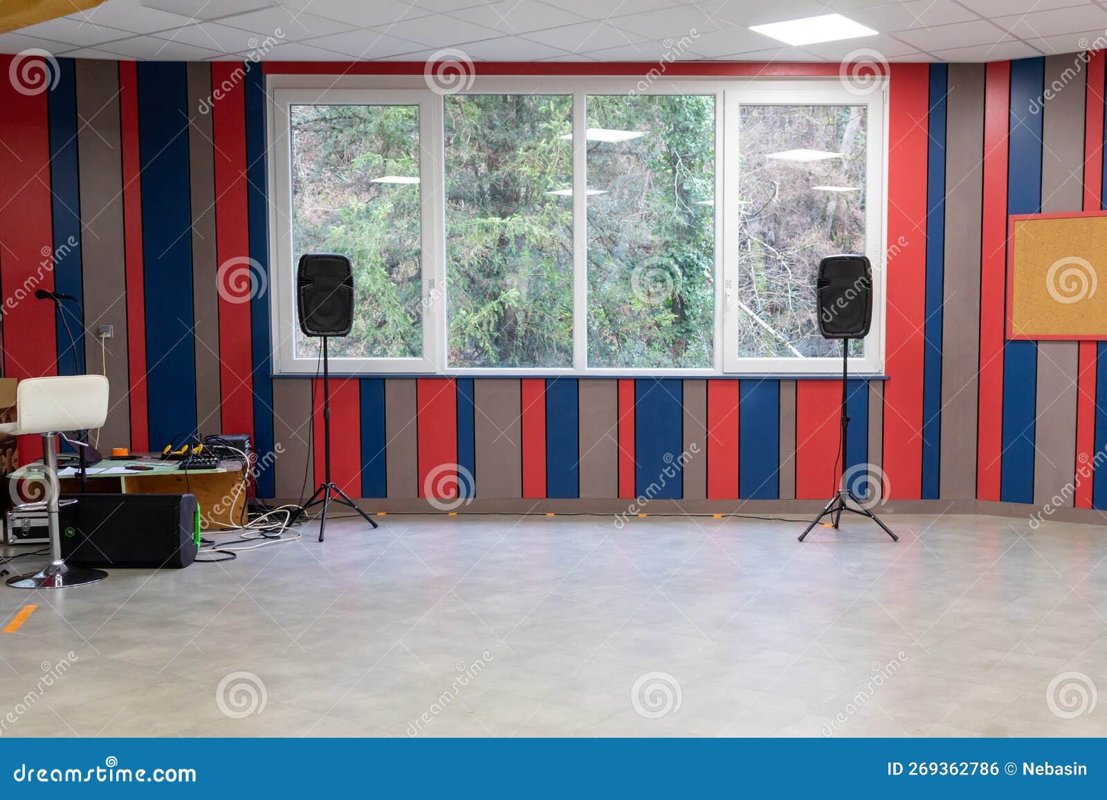 An Empty Event Space with a Large Window and Two Columns without People ...