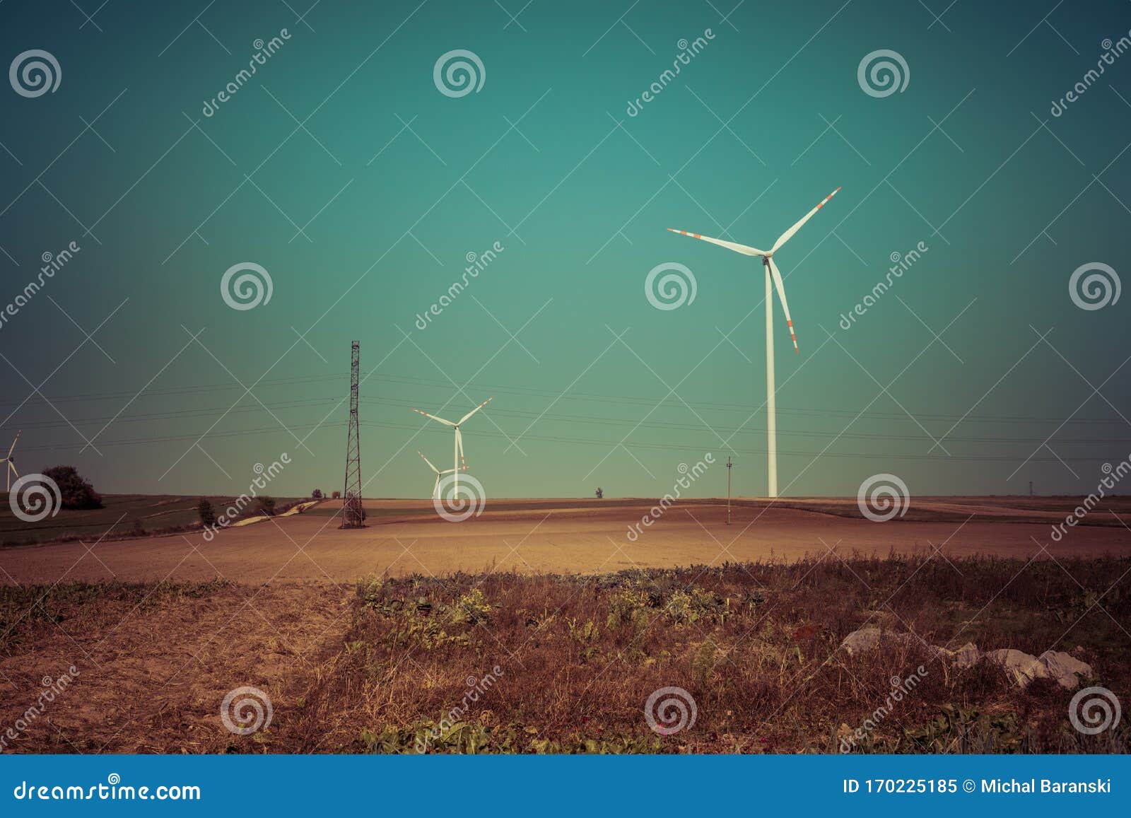 Empty Fields and Wind Turbines Over Clear Blue Sky Stock Image - Image ...