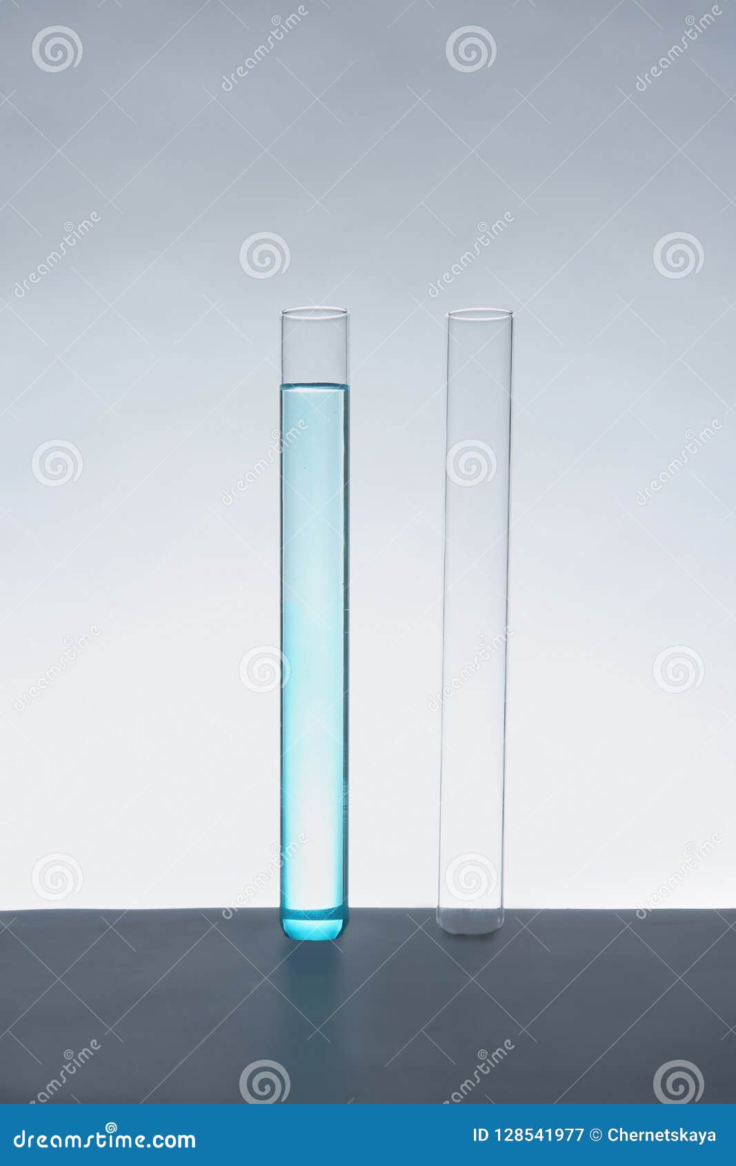 Empty and Filled Test Tubes on Table Against White Background Stock ...